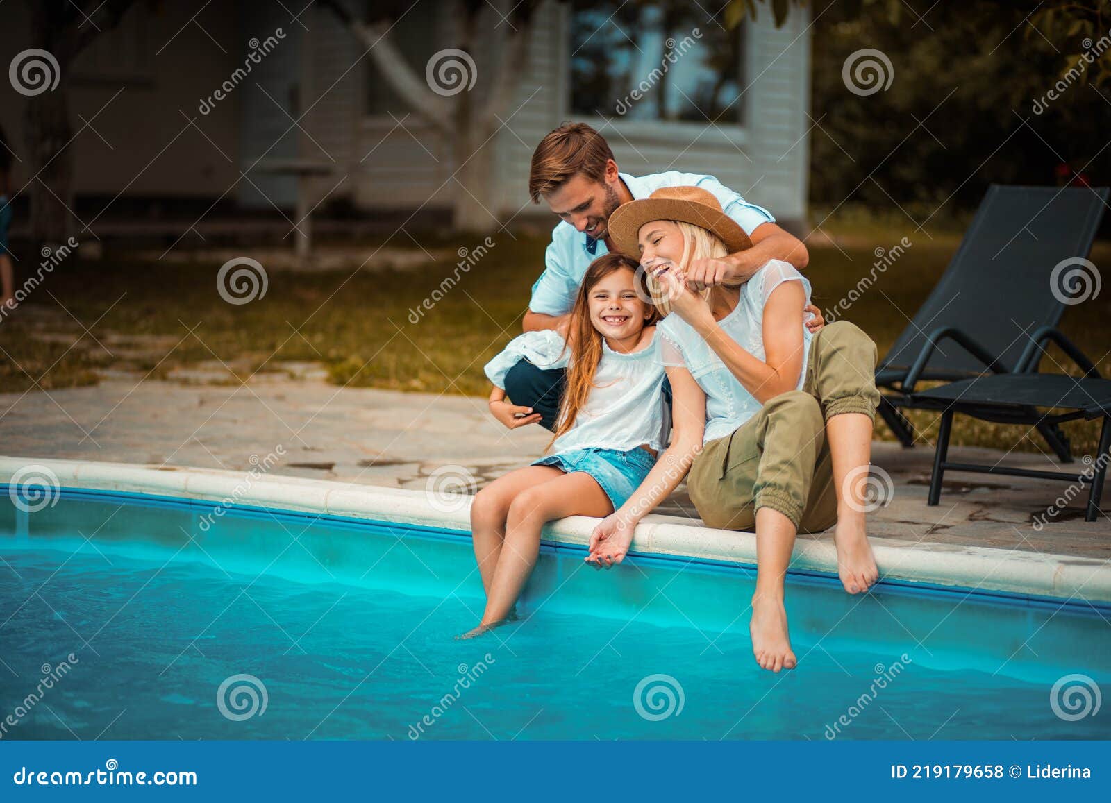 Family sitting by the pool stock photo. Image of outdoor - 219179658