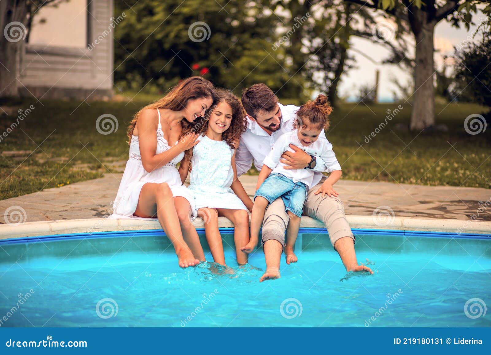 Family sitting by the pool stock image. Image of girls - 219180131