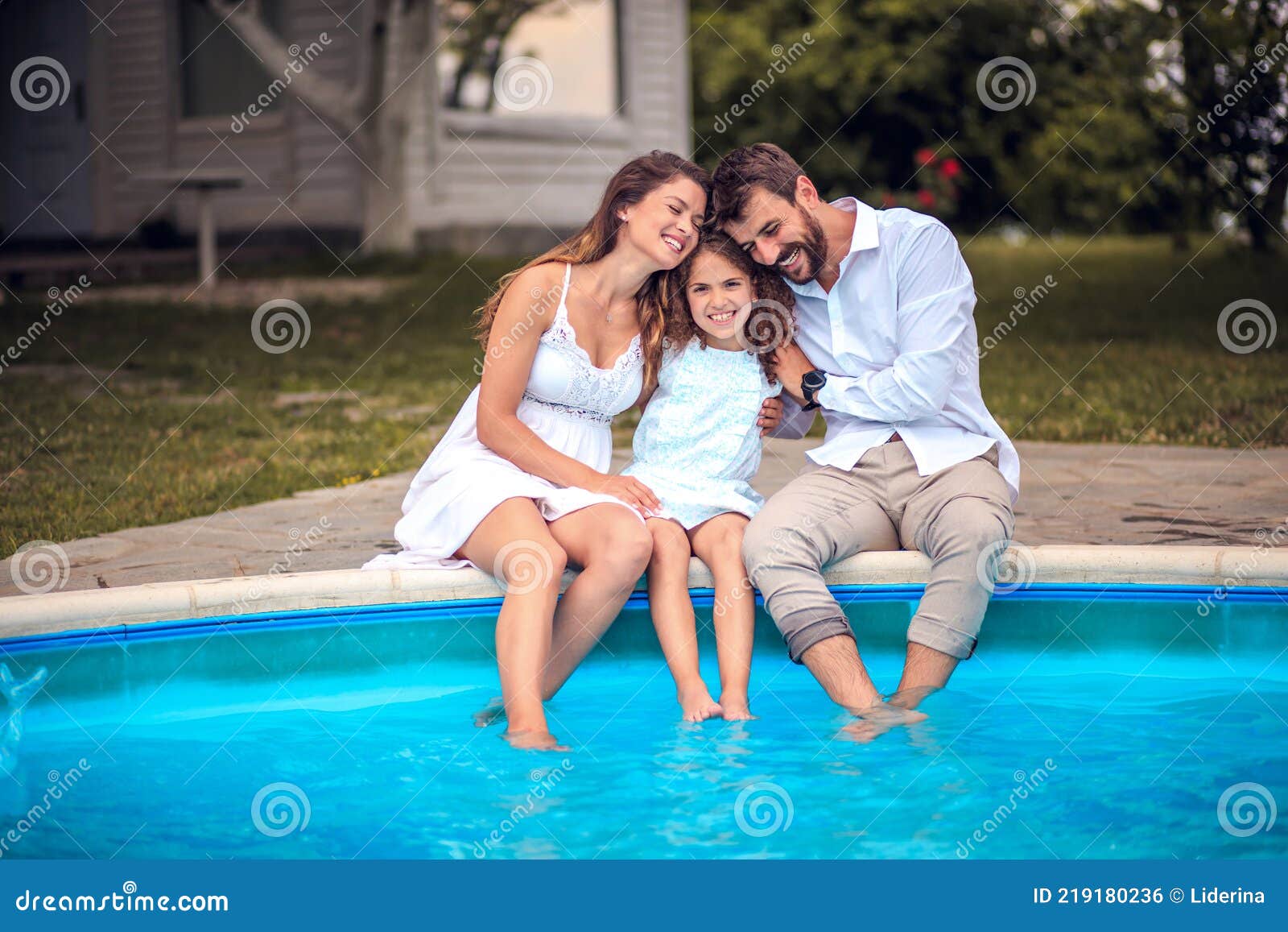 Family sitting by the pool stock photo. Image of portrait - 219180236