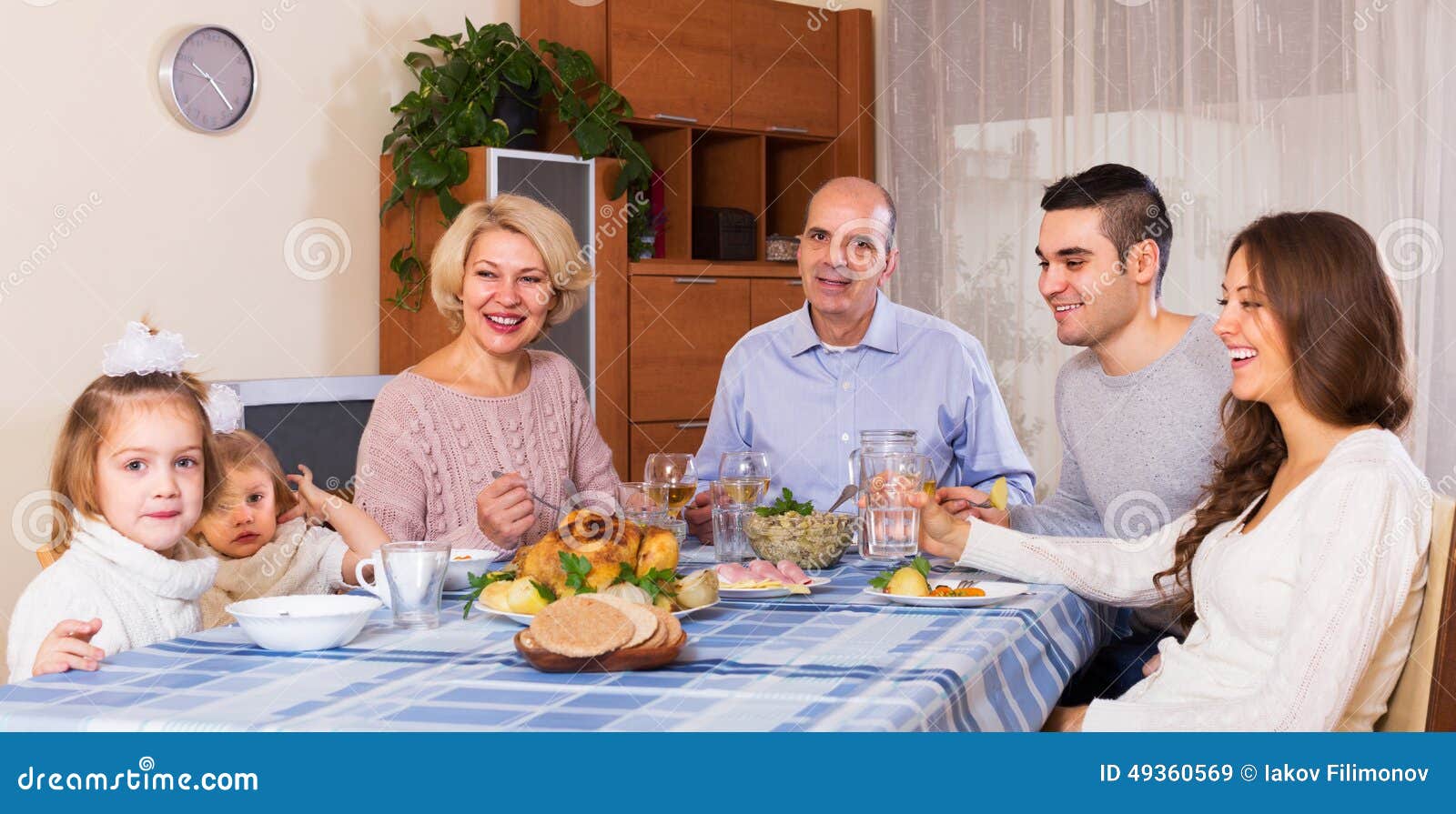 Family Sitting at Table for Dinner Stock Image - Image of little, food ...