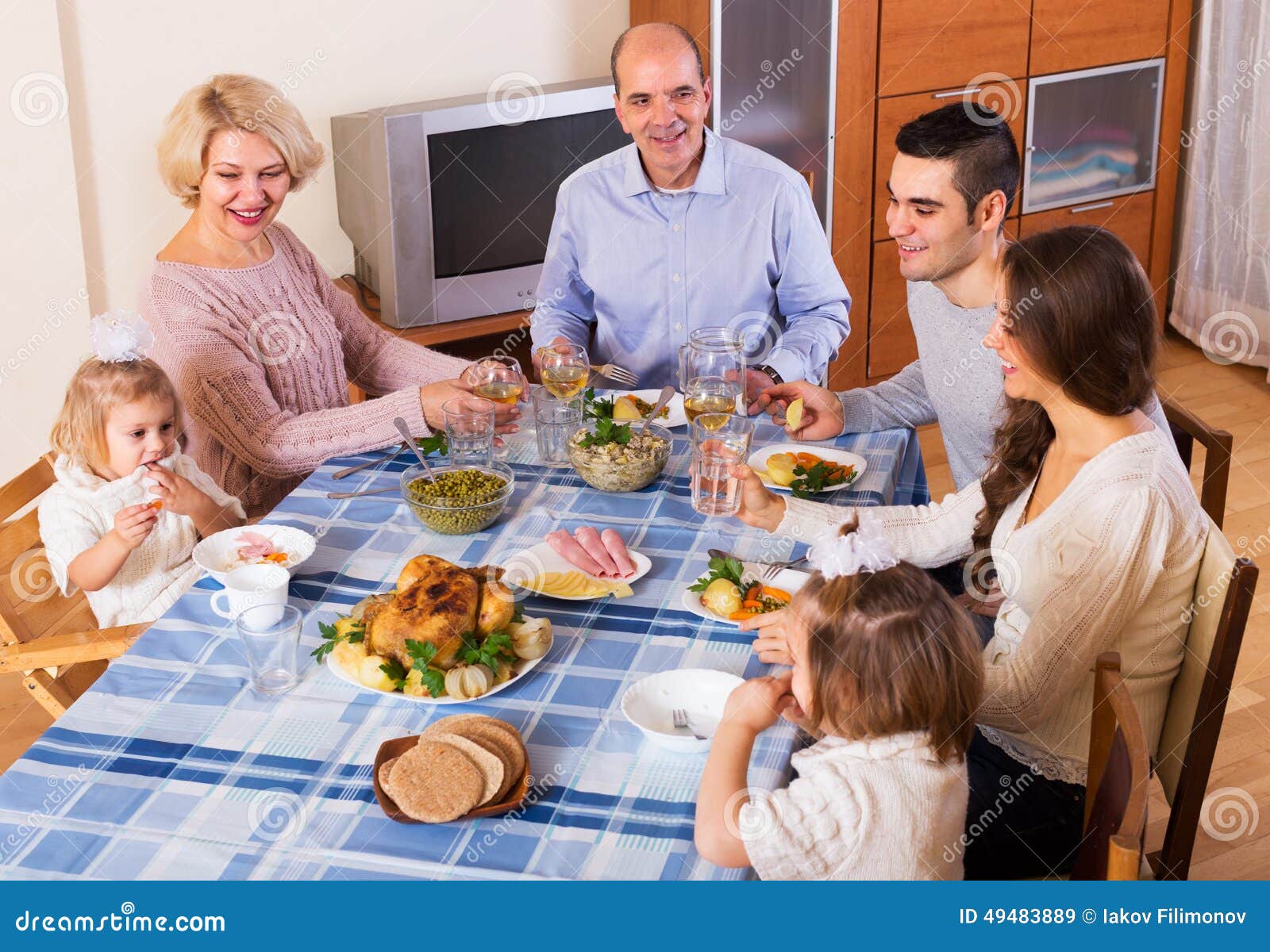 Family Sitting At Table For Dinner Stock Photo - Image: 49483889