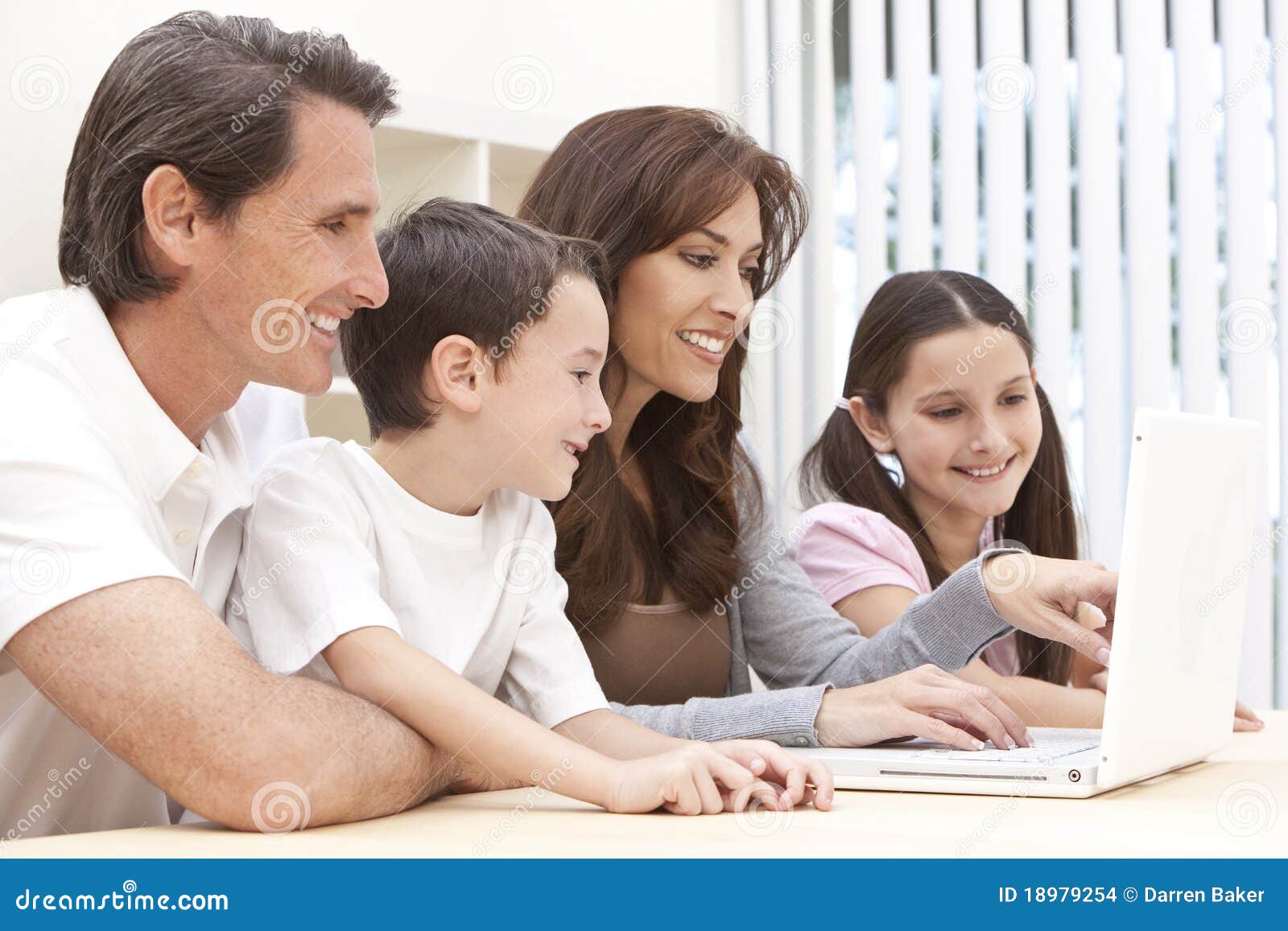 Family Sitting Using Laptop Computer at Home Stock Photo - Image of ...