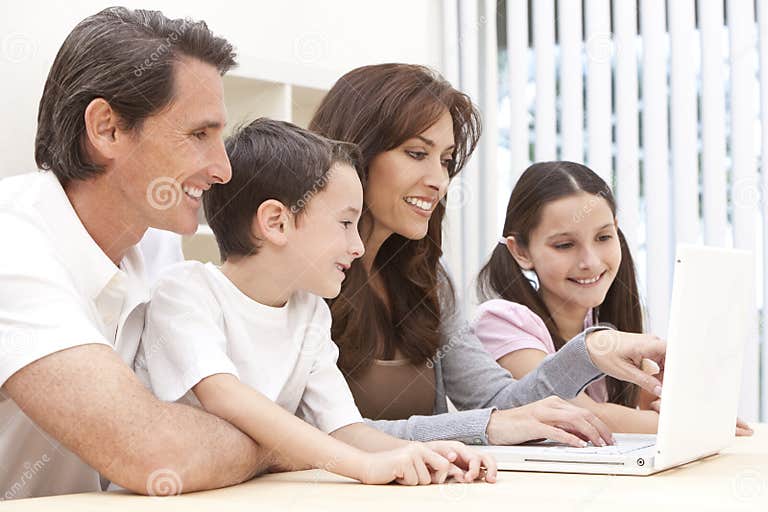 Family Sitting Using Laptop Computer at Home Stock Photo - Image of ...