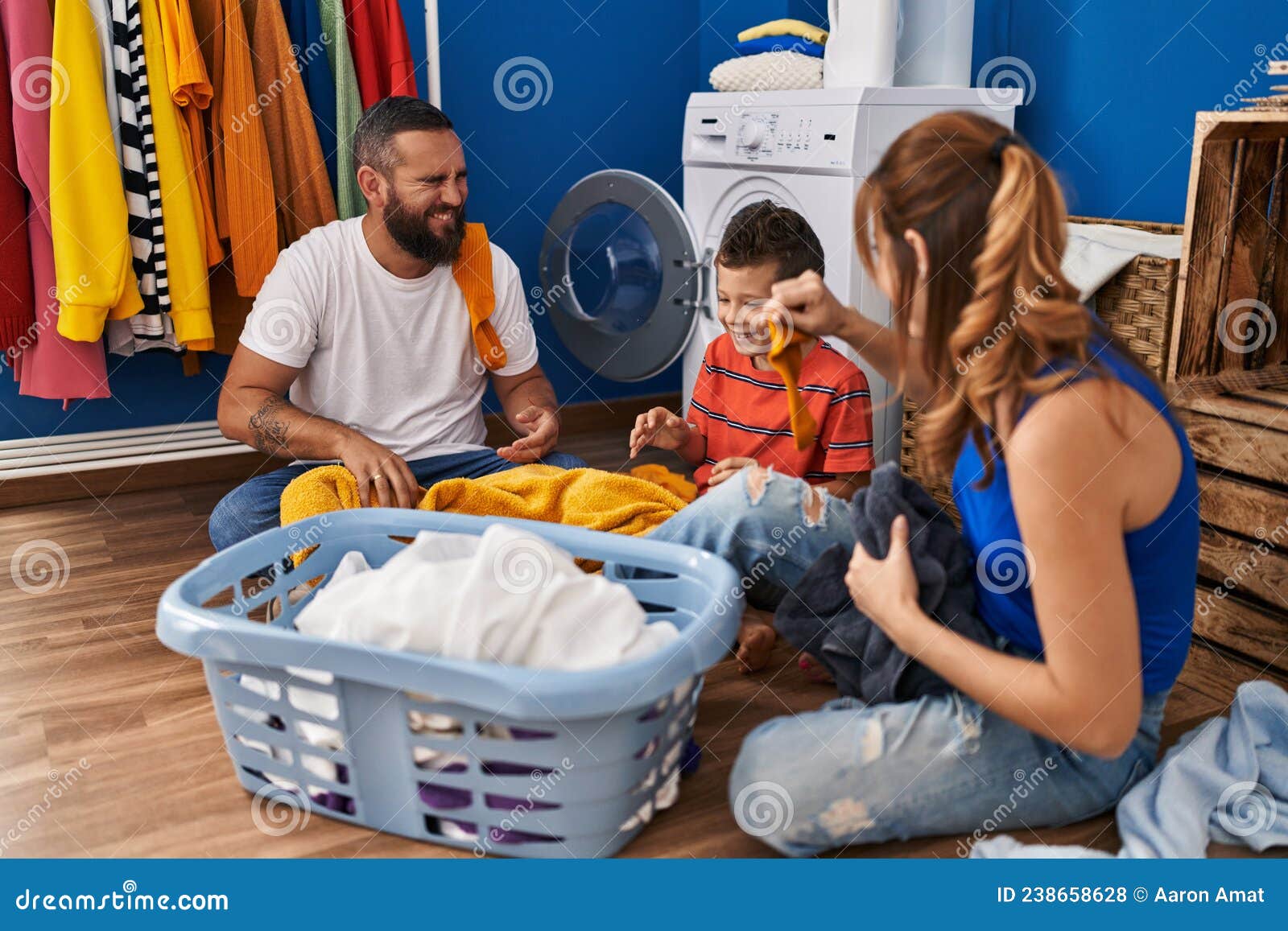 Family Smiling Confident Playing with Clothes at Laundry Room Stock ...