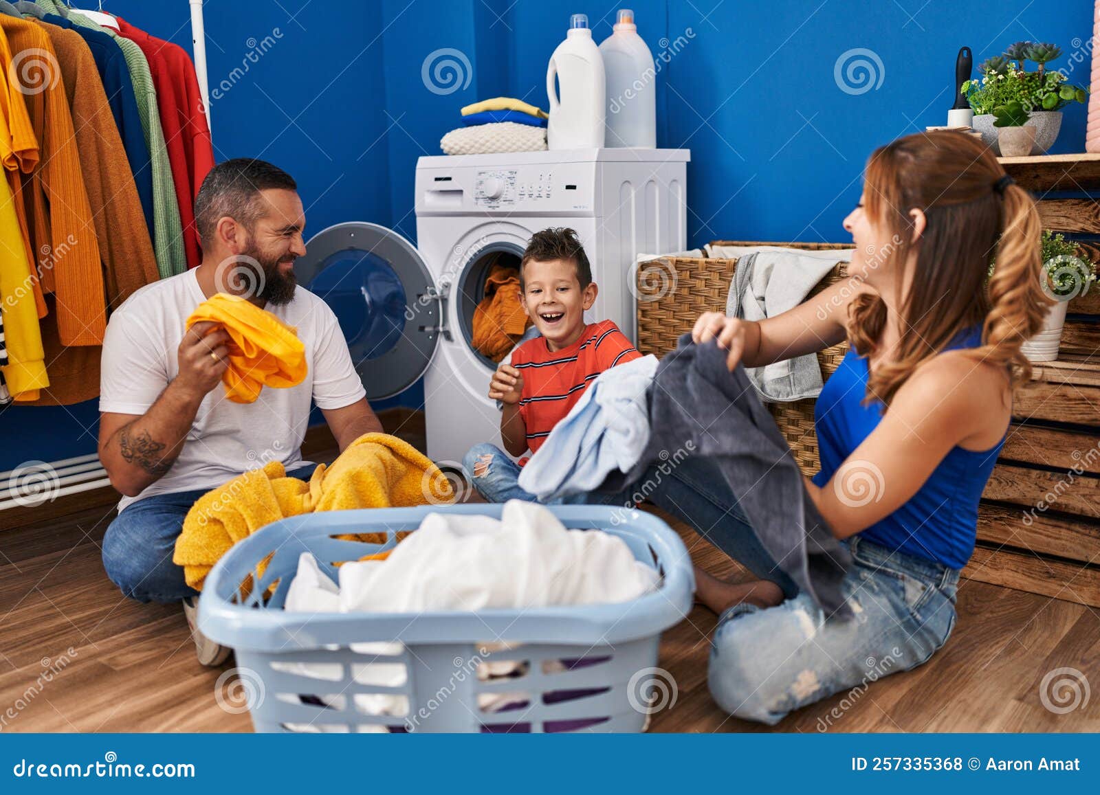 Family Smiling Confident Playing with Clothes at Laundry Room Stock ...