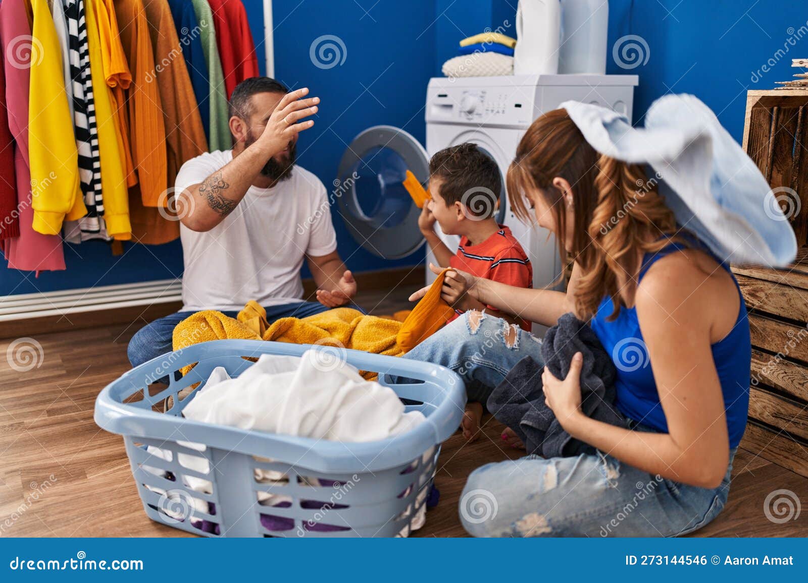 Family Smiling Confident Playing with Clothes at Laundry Room Stock ...