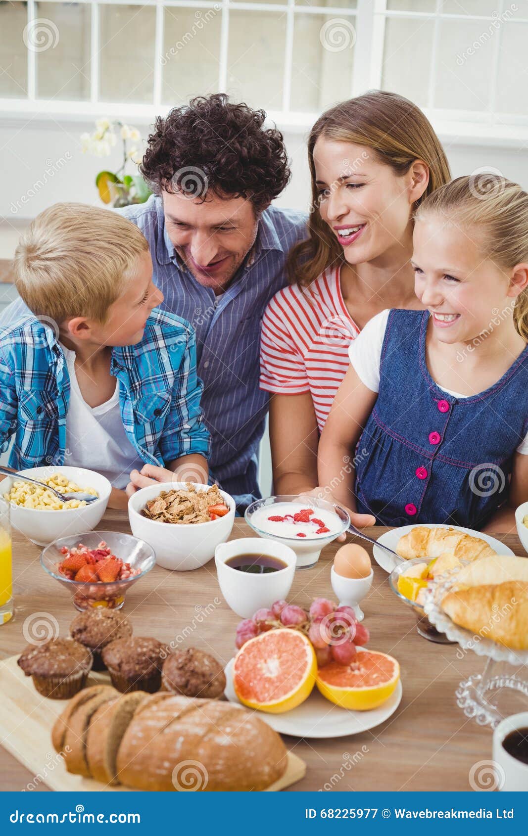 Family Smiling while Having Breakfast at Table Stock Image - Image of ...