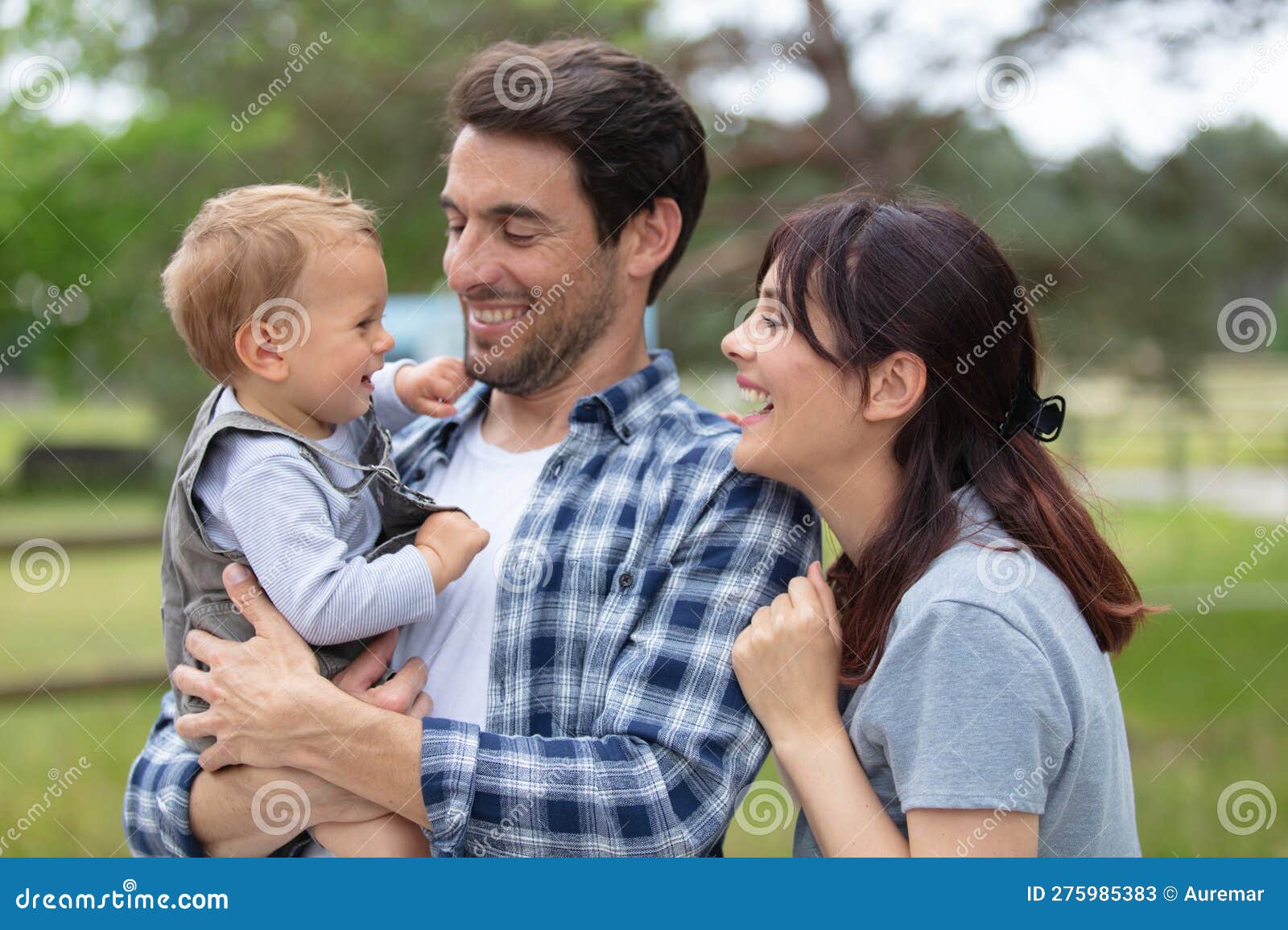 Family Smiling Together in Park Stock Image - Image of blue, lifestyle ...