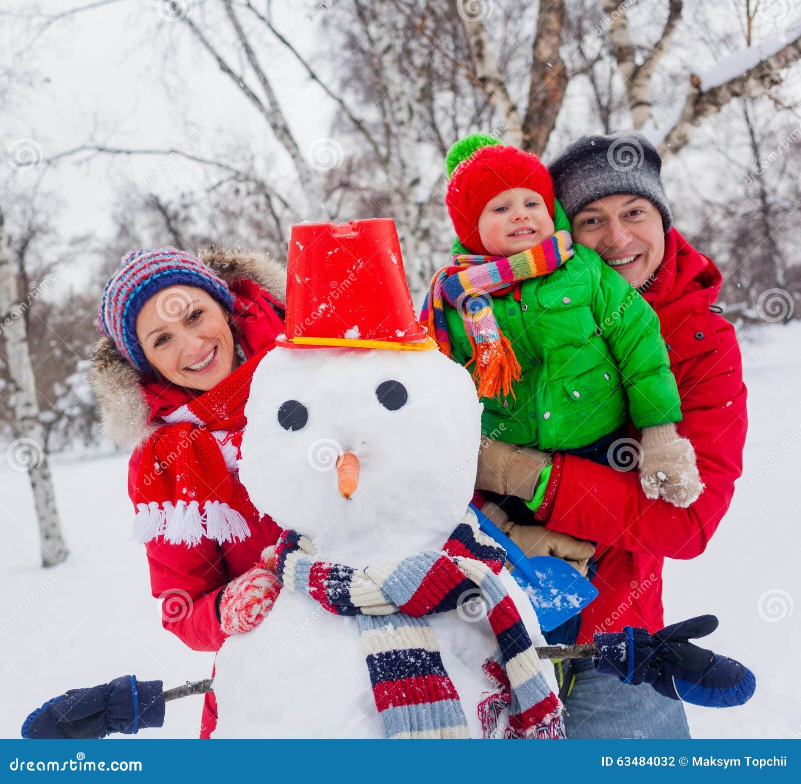 Family with a snowman stock photo. Image of parent, beautiful - 63484032