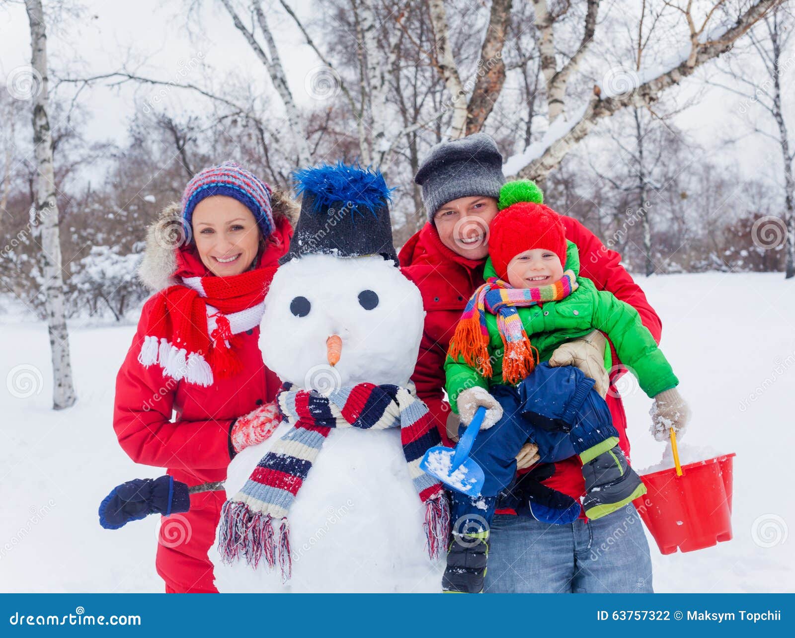 Family with a snowman stock photo. Image of outdoor, happiness - 63757322