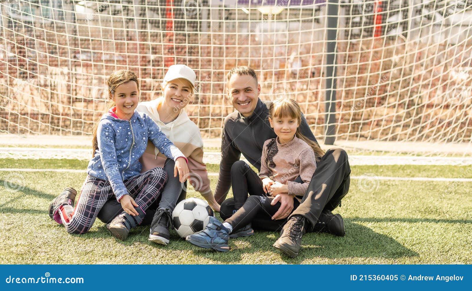 Family with Soccer Ball in Stadium Stock Image - Image of sitting ...