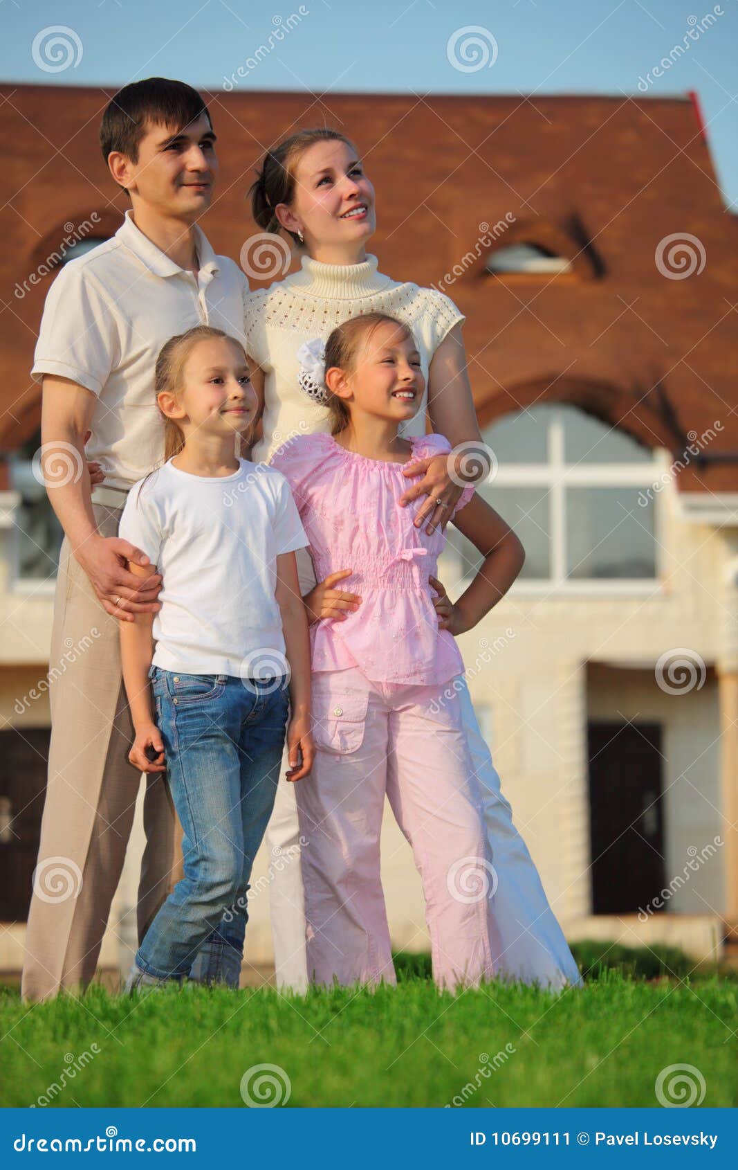 Family Stands on Grass Against House Stock Image - Image of daughter ...