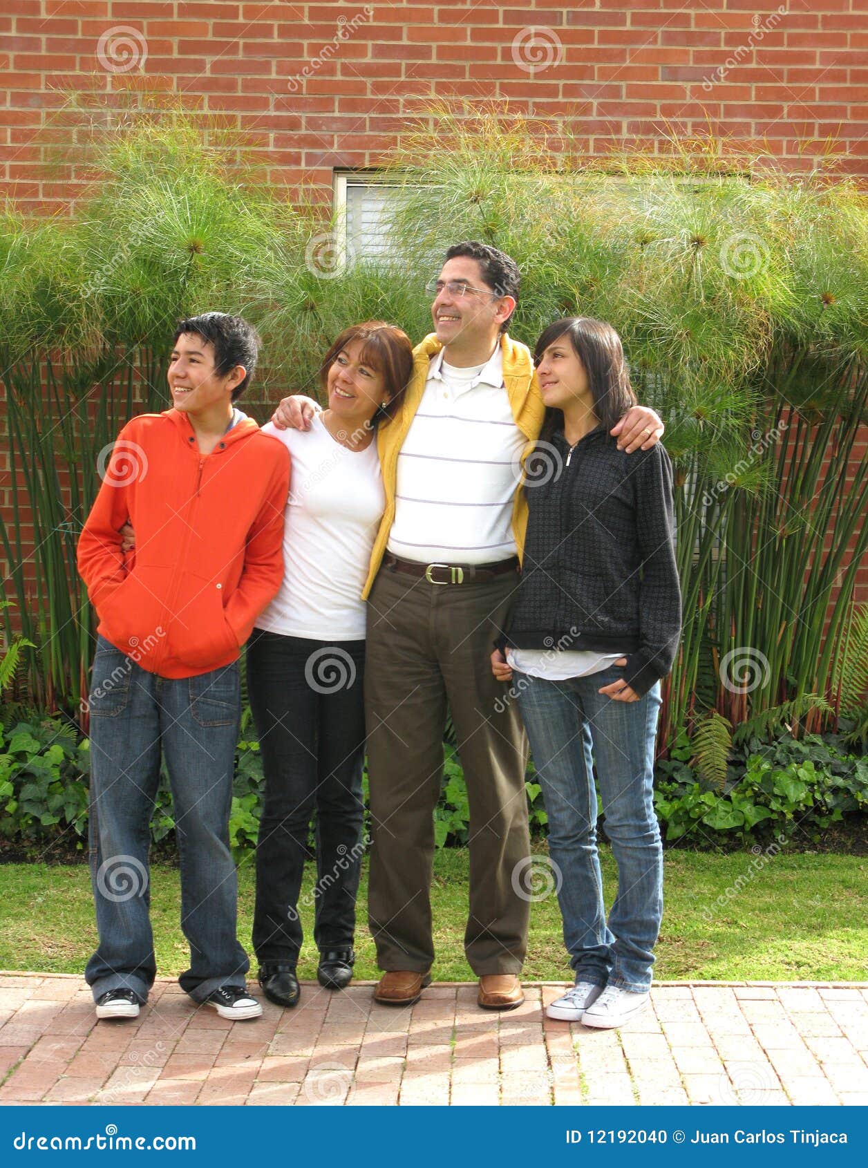 Family Stands on Grass Against House Stock Photo - Image of girl ...