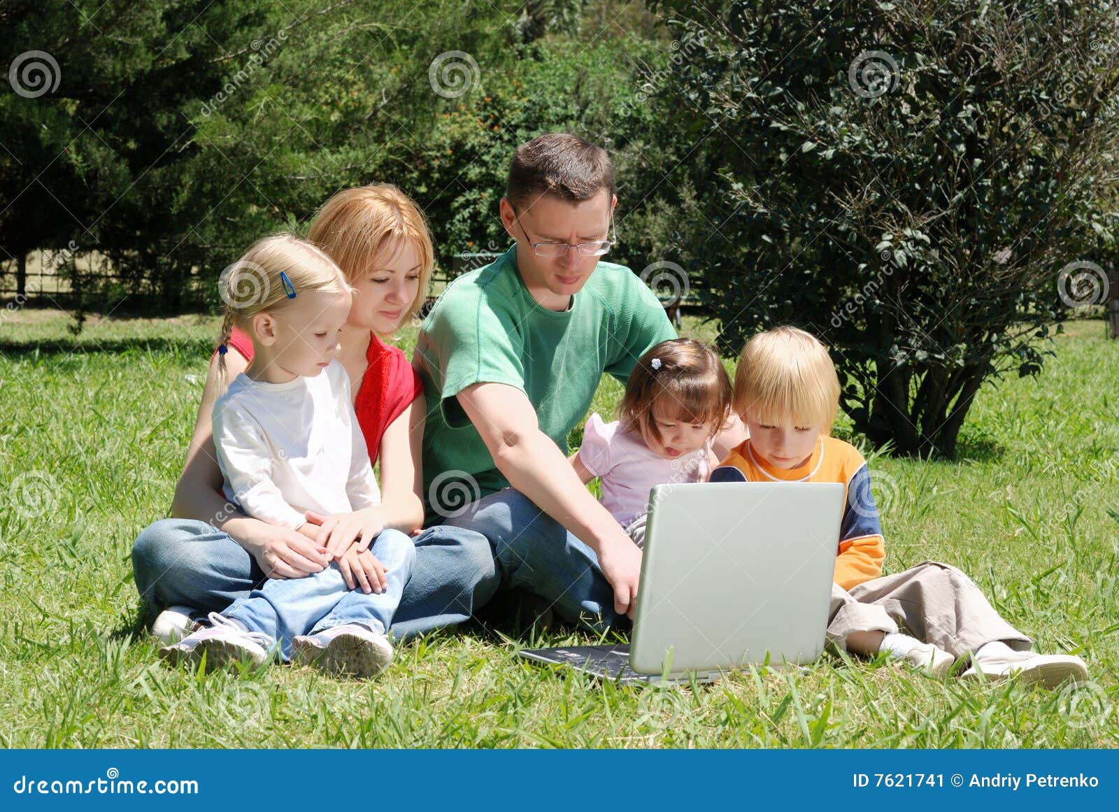 Family studying the laptop stock image. Image of grass - 7621741