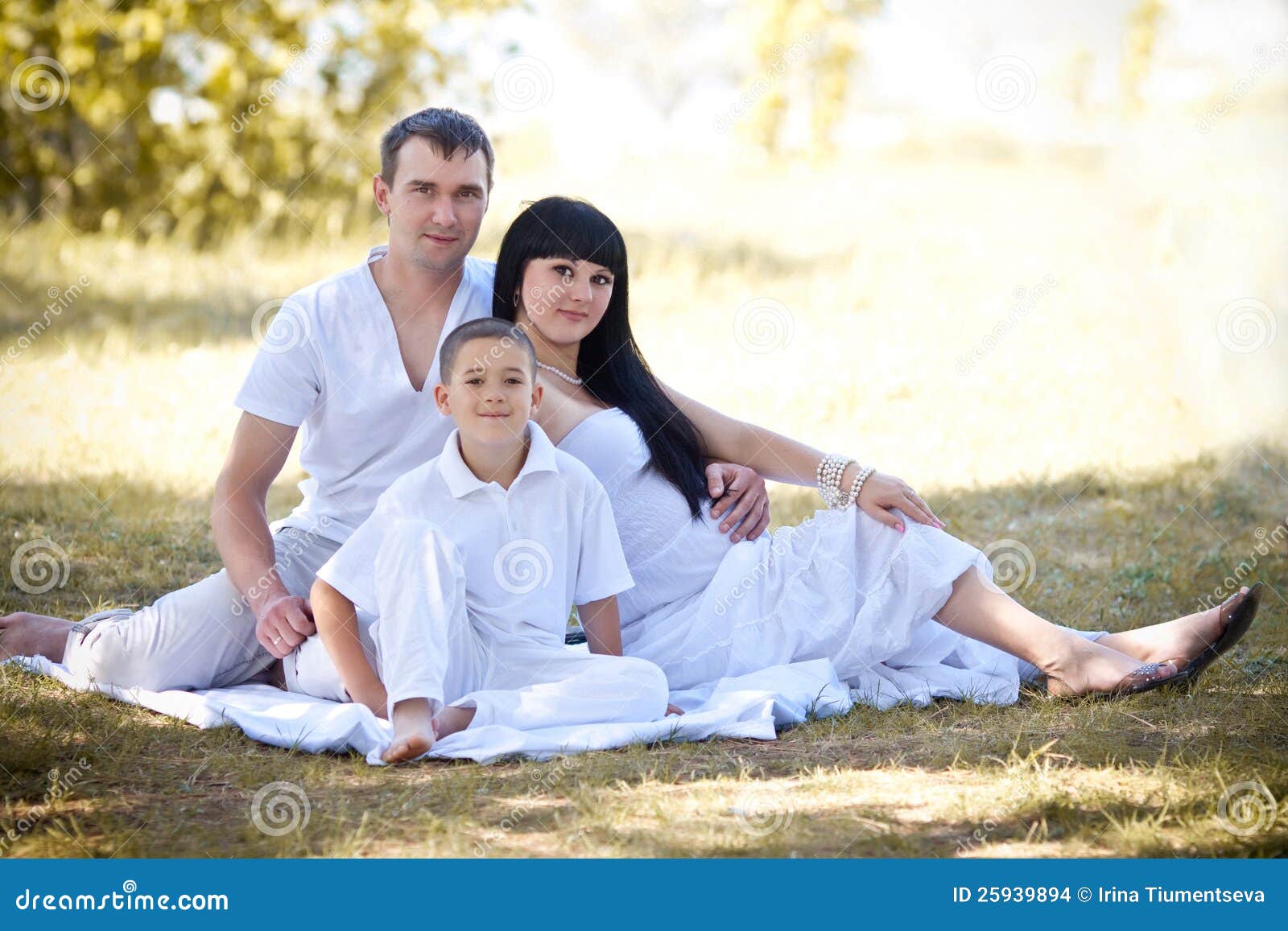 Family with a Sun on the Nature Stock Photo - Image of belly, leisure ...