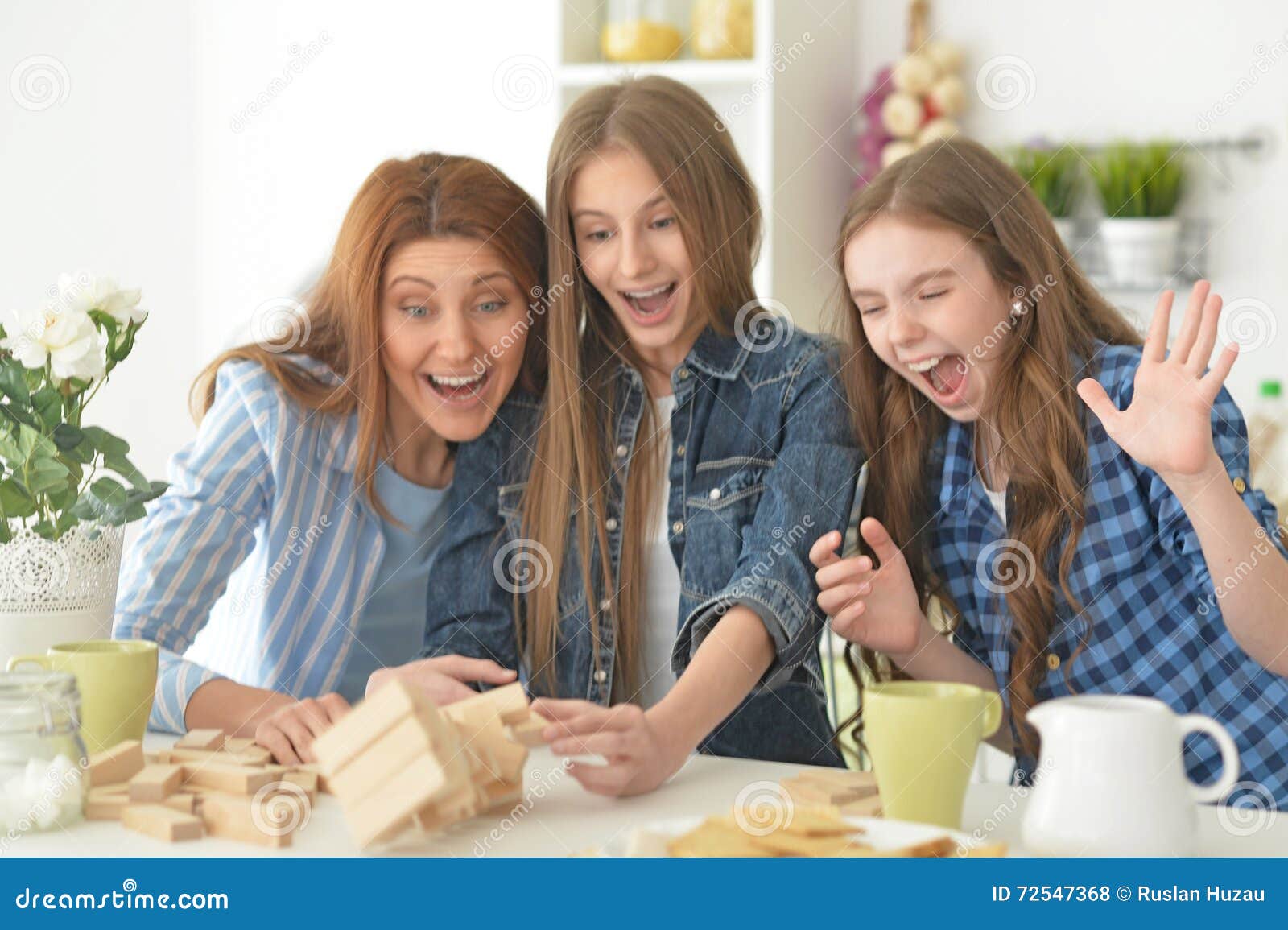 Family at the Table Playing Board Game Stock Photo - Image of indoors ...