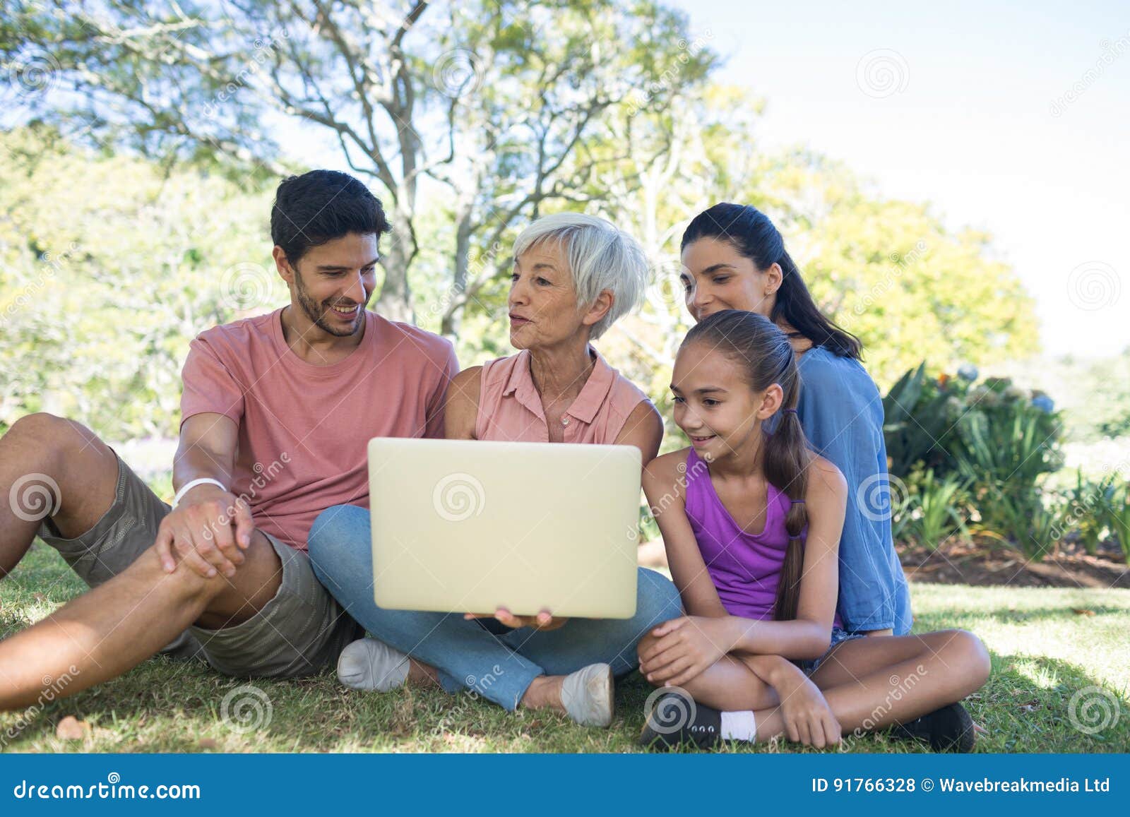 Family Talking while Using Laptop in the Park Stock Photo - Image of ...