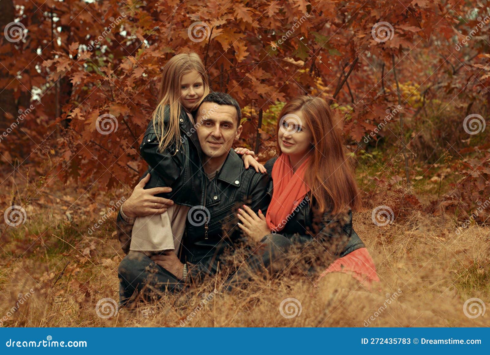 A Family of Three in Black Leather Jackets in the Park. Stock Image ...