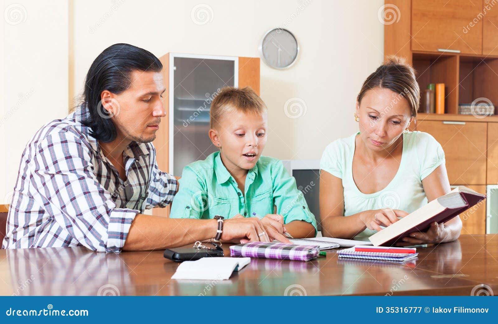 Family of Three Doing Homework in Home Stock Image - Image of book ...