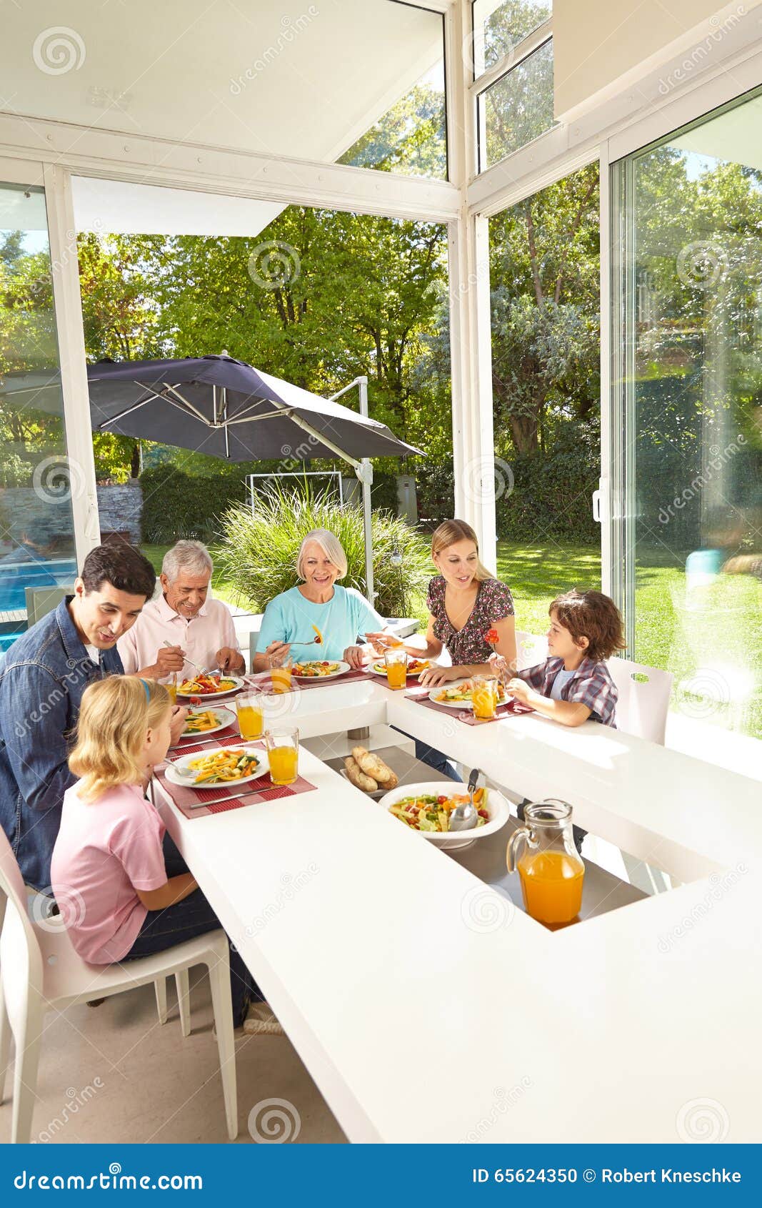 Family in Three Generations Eating at Lunch Table Stock Photo - Image ...