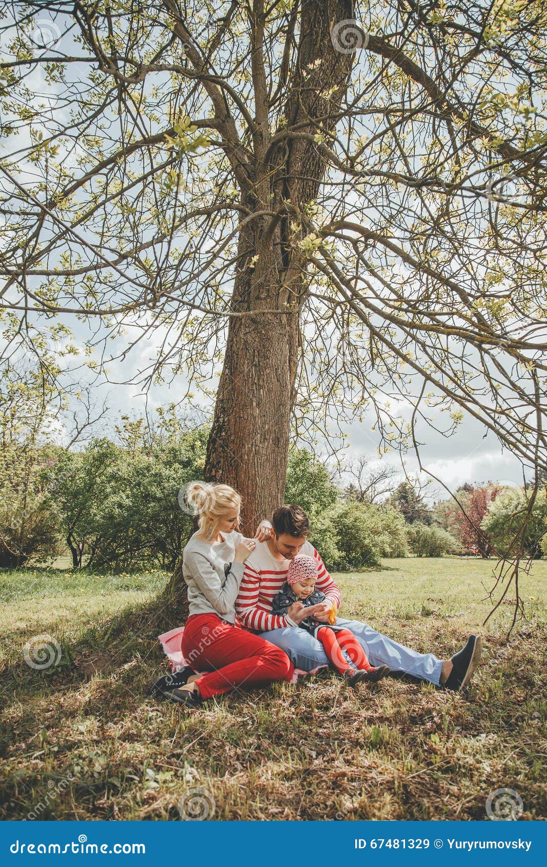 Family of Three People Resting Under a Tree Stock Image - Image of ...