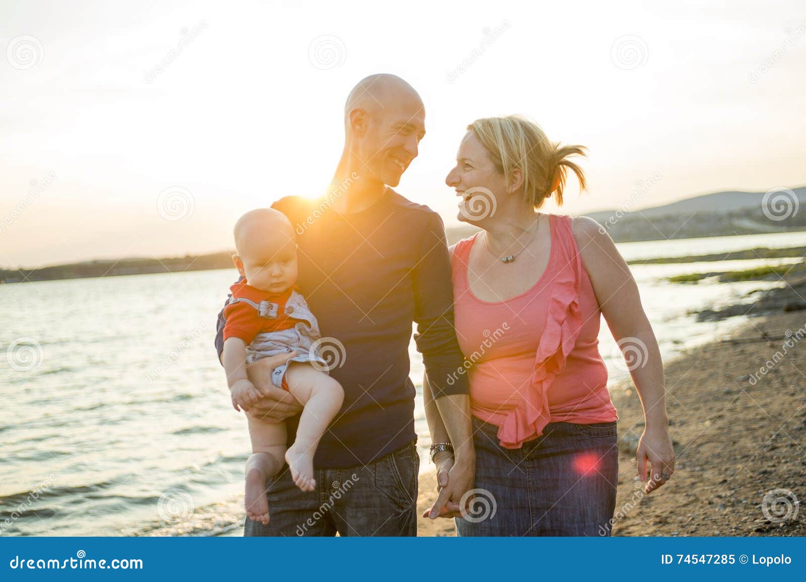 Family of Three Person is Standing on Sunset and Sea Backdrop Stock ...