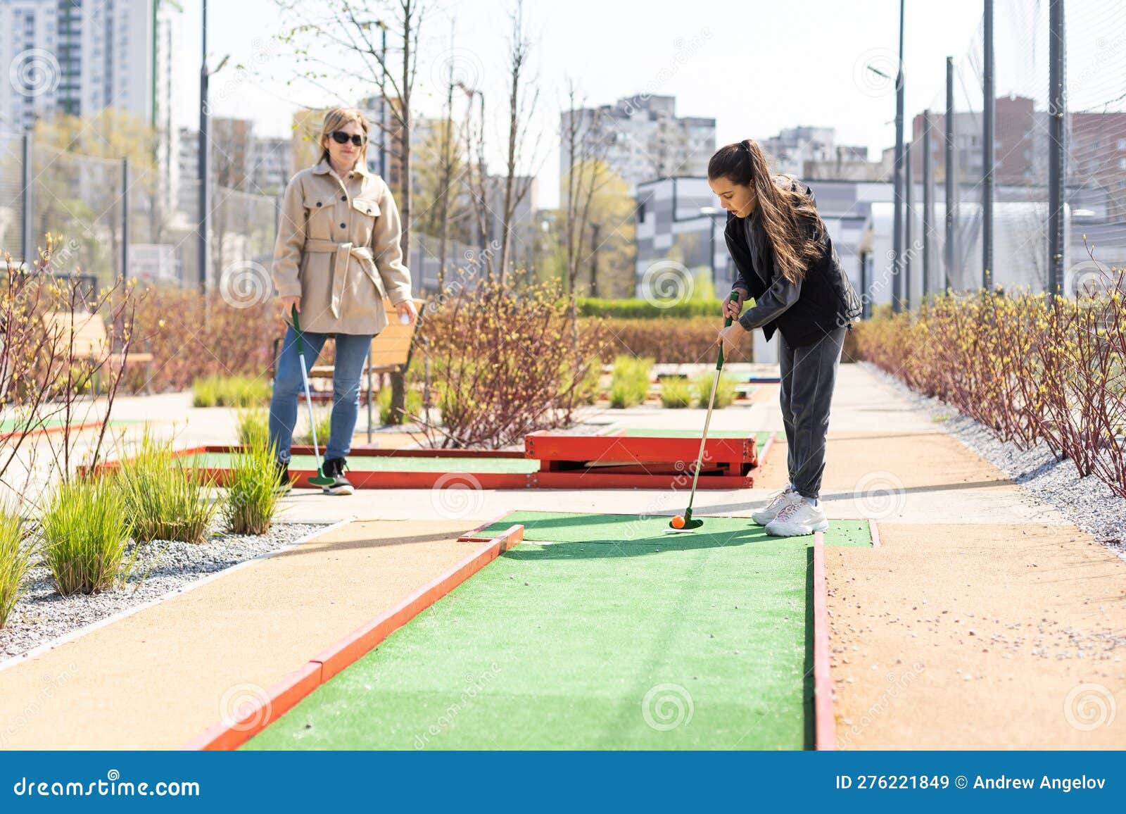 Family Time Playing Mini-Golf in the Summer Stock Image - Image of ...