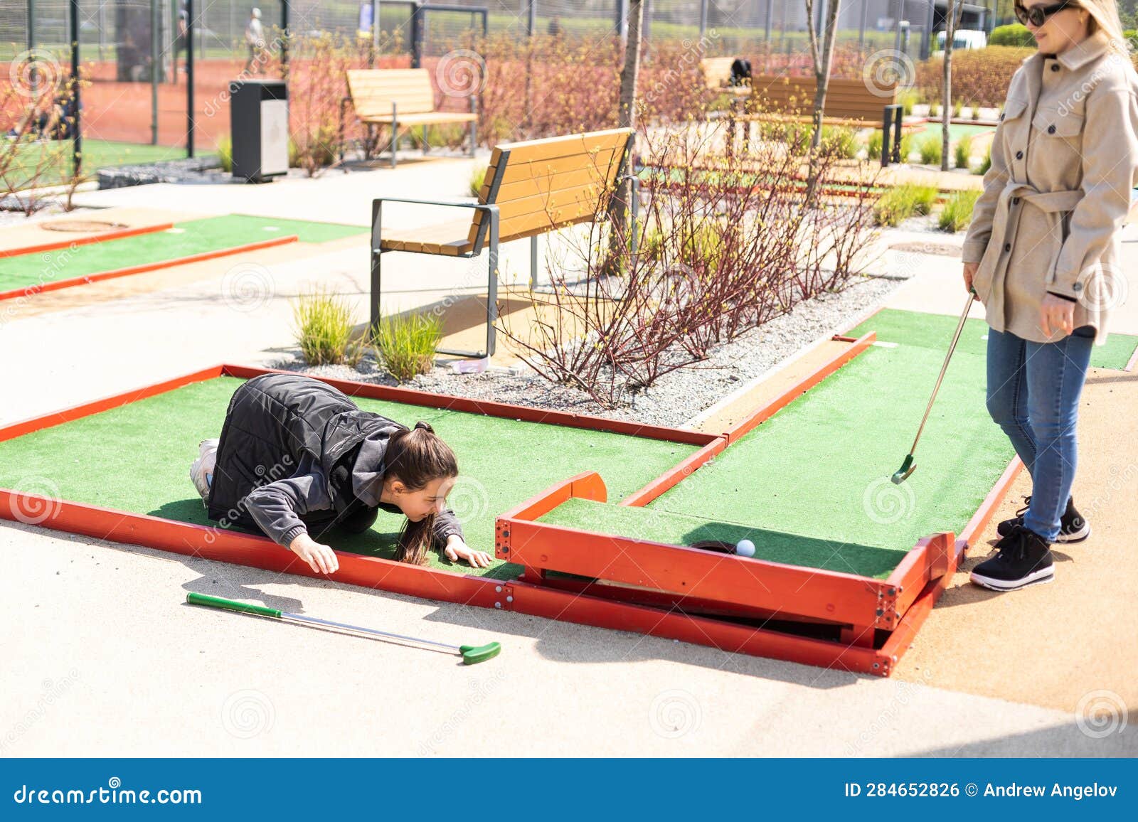Family Time Playing Mini-Golf in the Summer Stock Photo - Image of ...