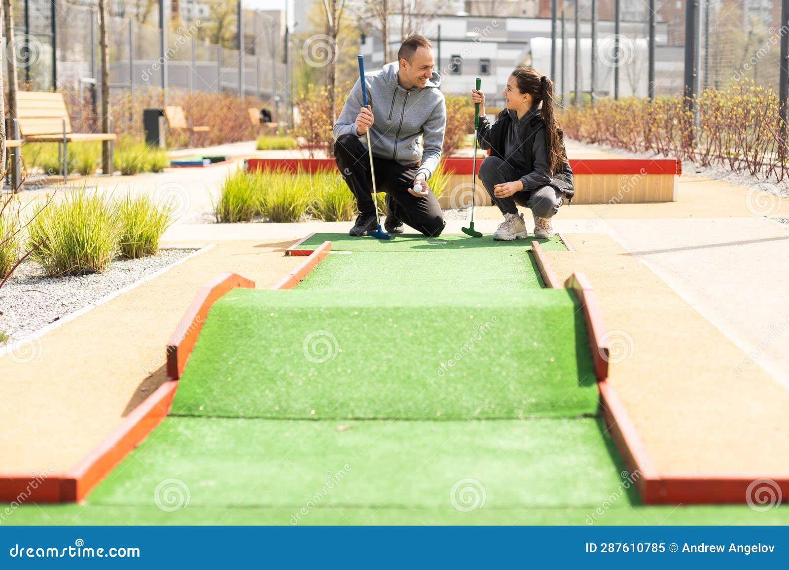 Family Time Playing Mini-Golf in the Summer Stock Image - Image of ...