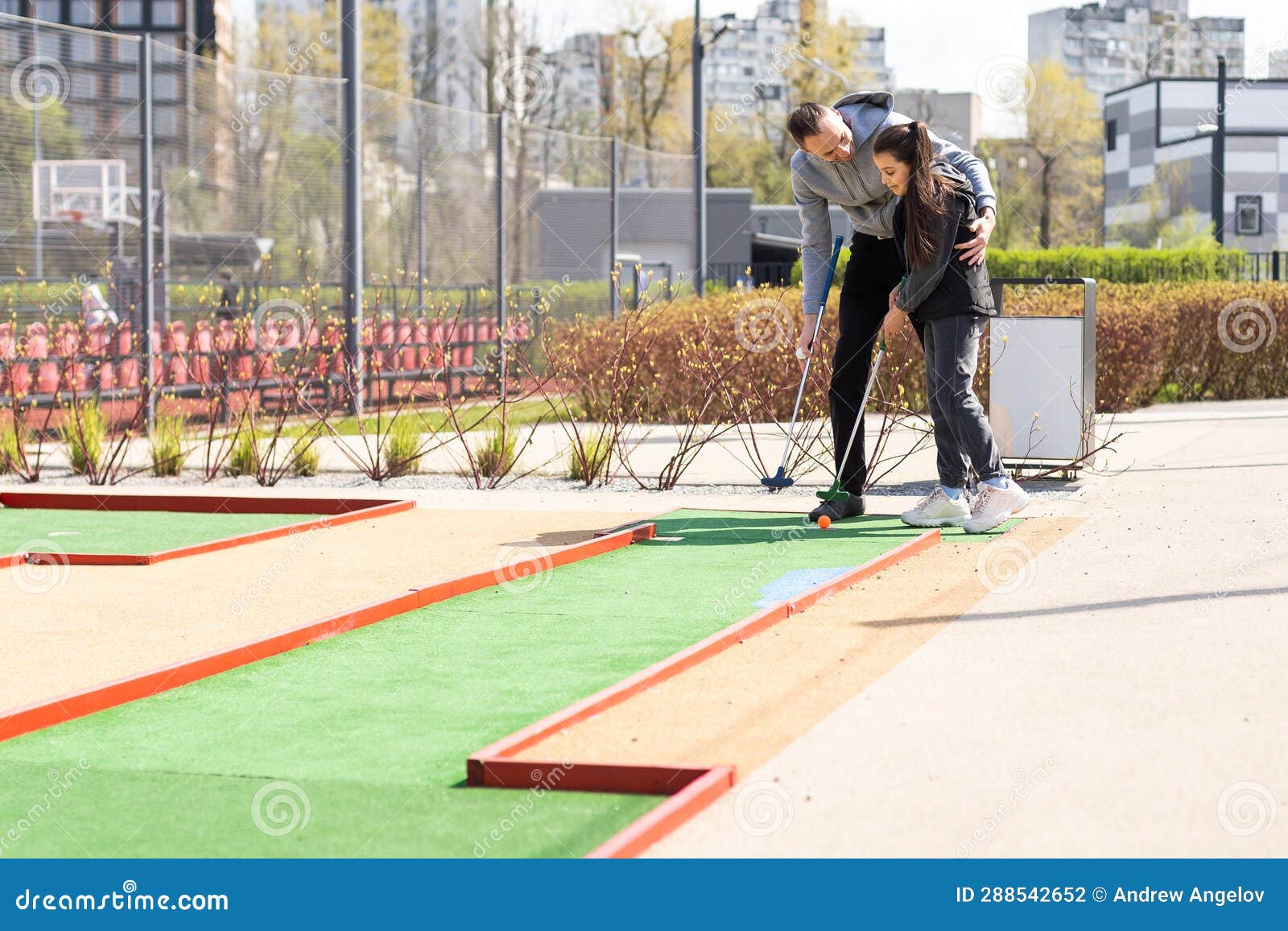 Family Time Playing Mini-Golf in the Summer Stock Photo - Image of ball ...