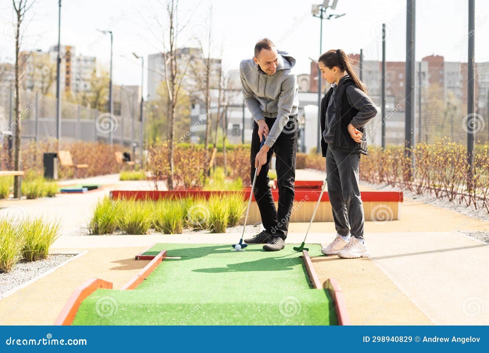 Family Time Playing Mini-Golf in the Summer Stock Image - Image of ...