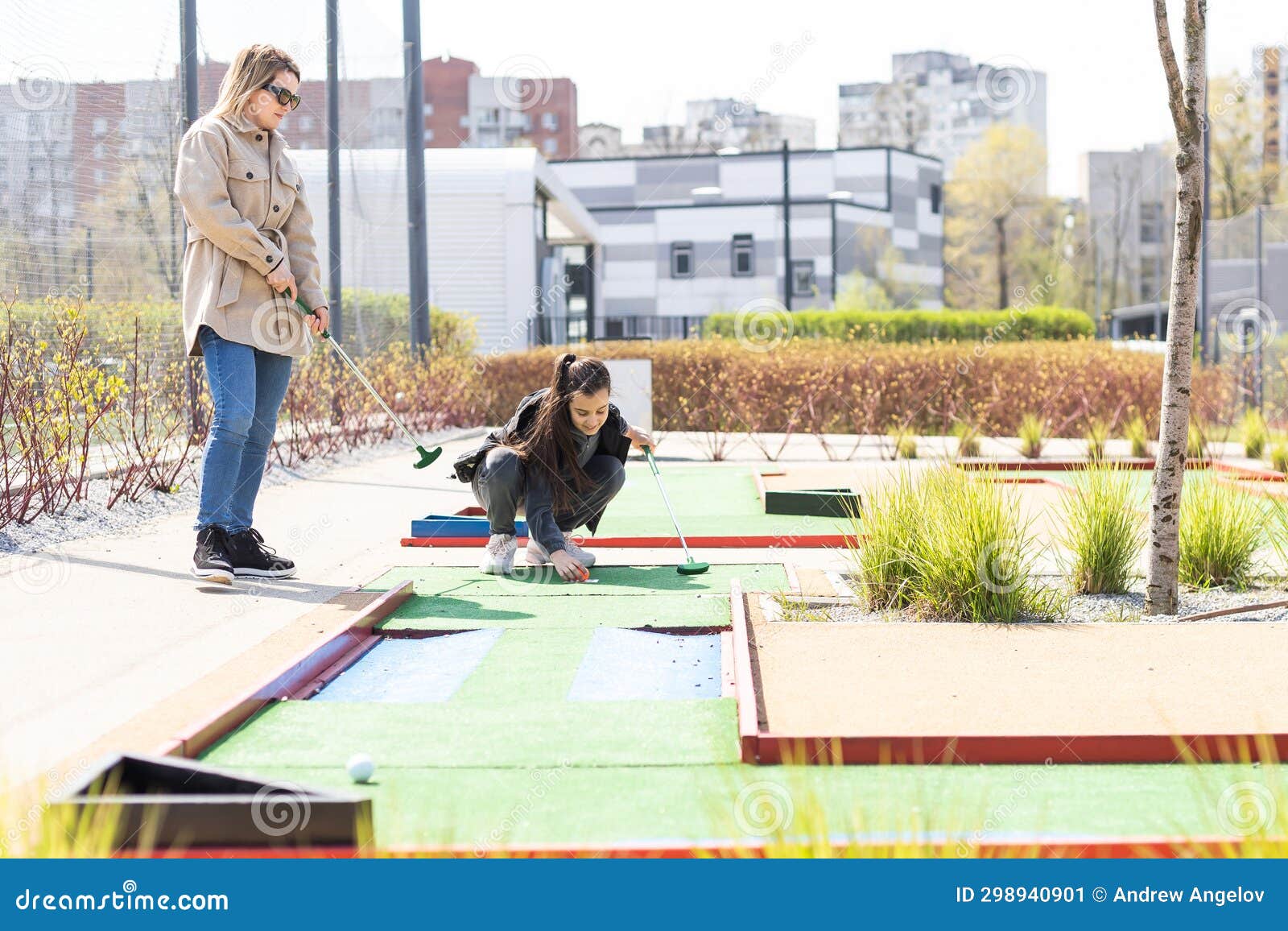 Family Time Playing Mini-Golf in the Summer Stock Image - Image of ...