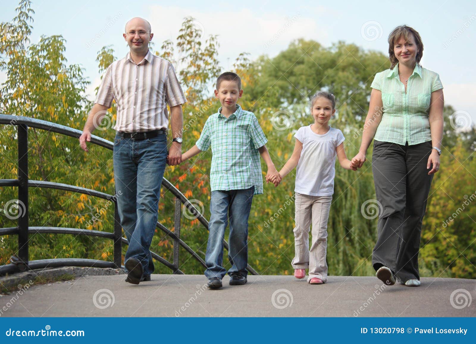 Family with Two Children is Walking on Bridge Stock Photo - Image of ...