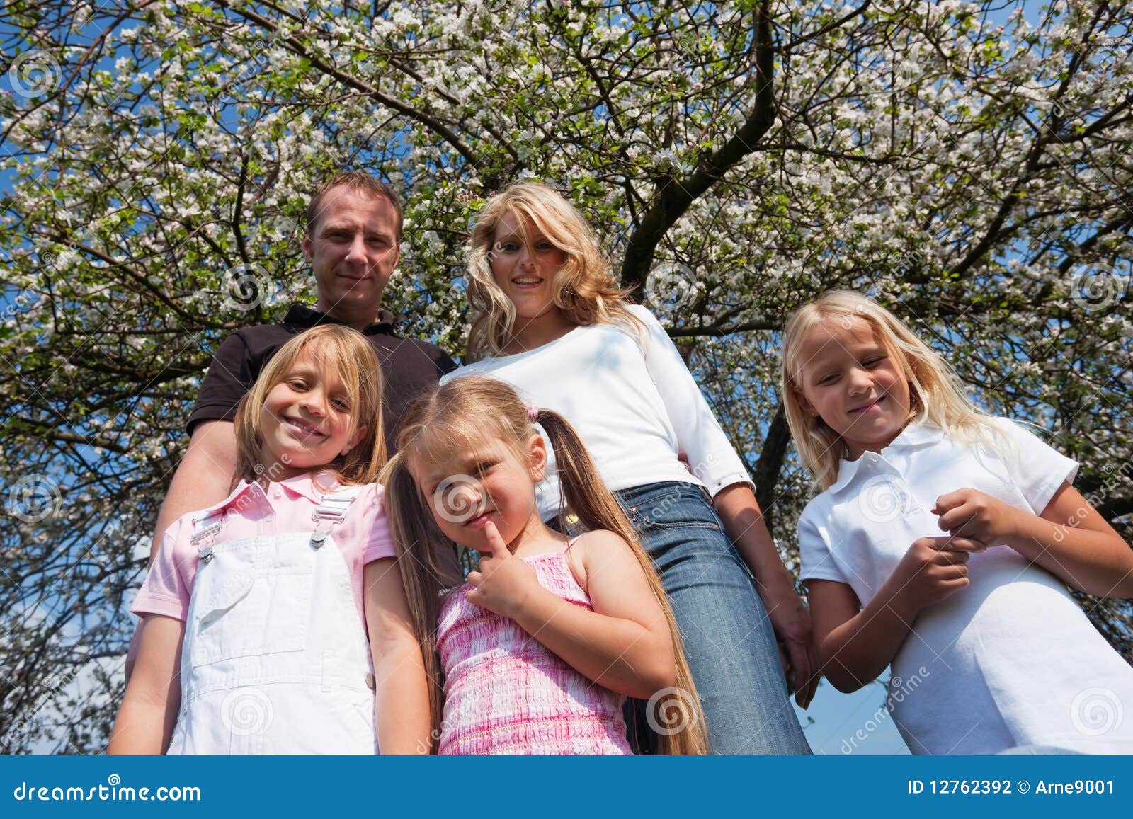 Family Under Apple Tree in Spring Stock Photo - Image of girls, couple ...