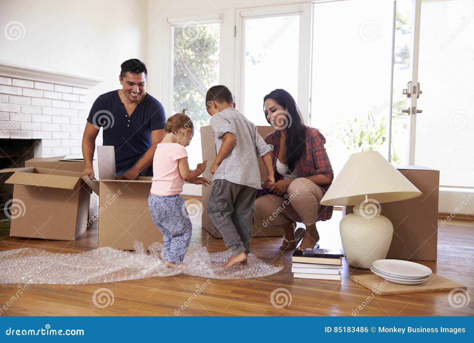 Family Unpacking Boxes in New Home on Moving Day Stock Photo - Image of ...