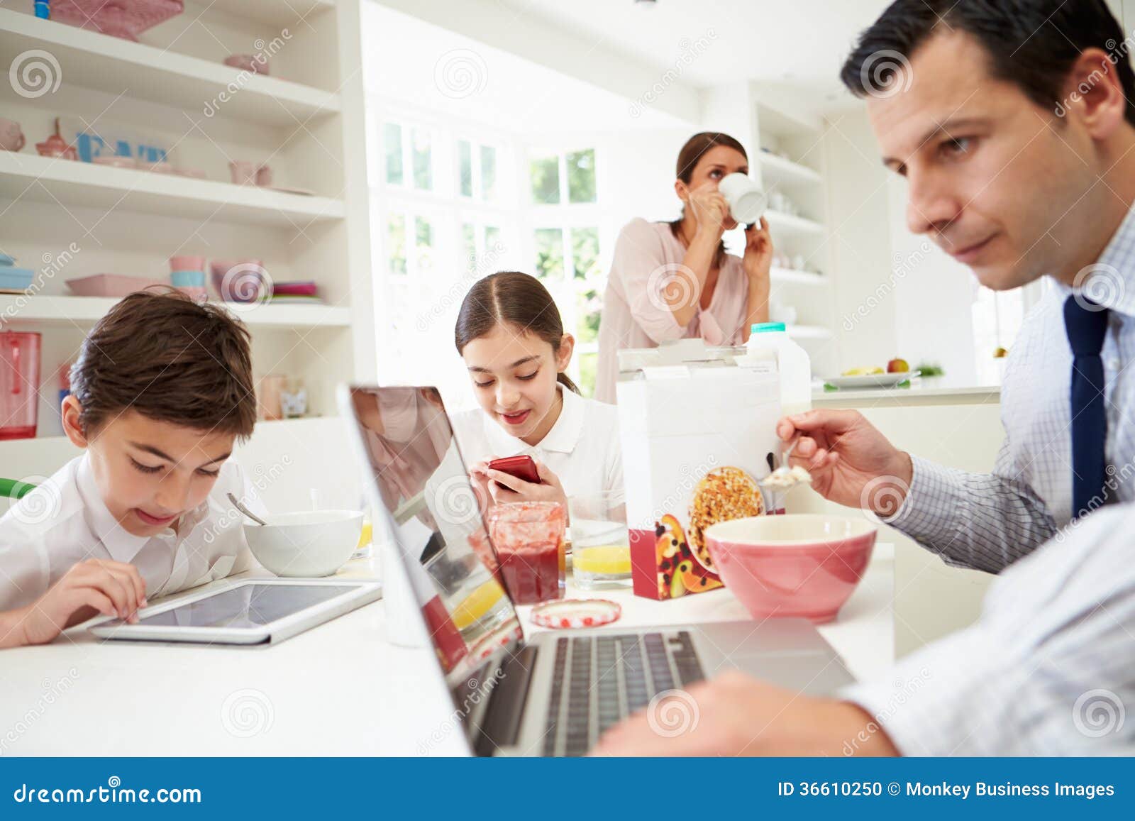 Family Using Digital Devices at Breakfast Table Stock Photo - Image of ...