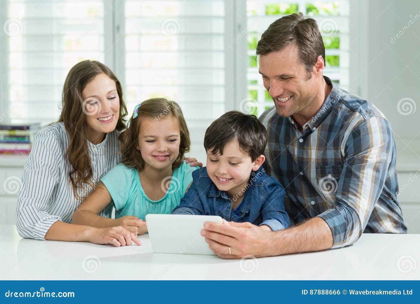 Family Using Digital Tablet in Living Room at Home Stock Photo - Image ...