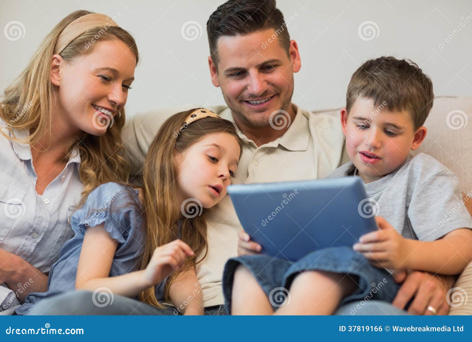 Family Using Digital Tablet Together on Sofa Stock Photo - Image of ...