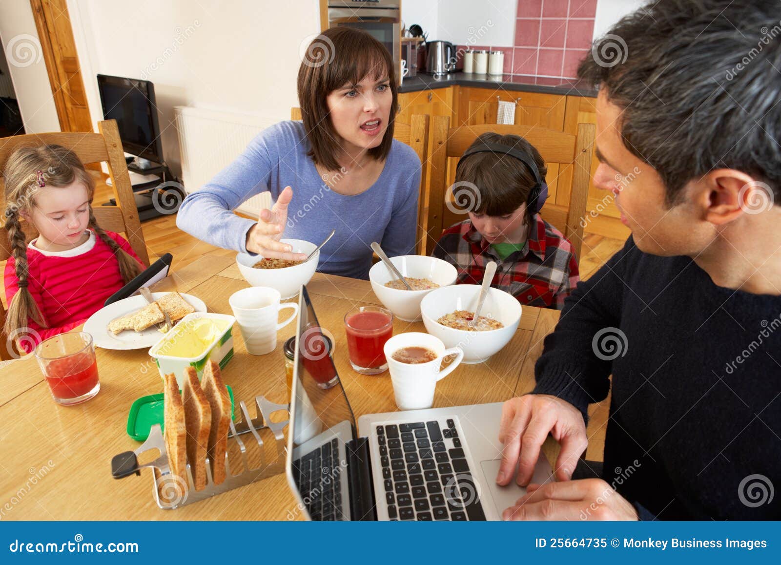 Family Using Gadgets Whilst Eating Breakfast Stock Image - Image of ...