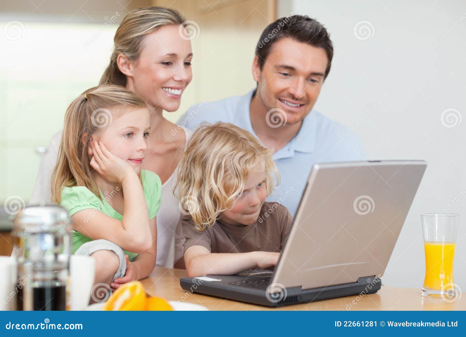 Family Using the Internet in the Kitchen Stock Image - Image of family ...