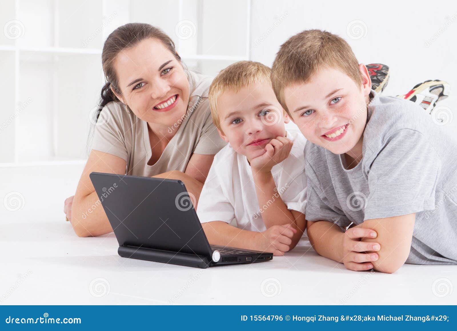 Family using laptop stock photo. Image of lying, communication - 15564796