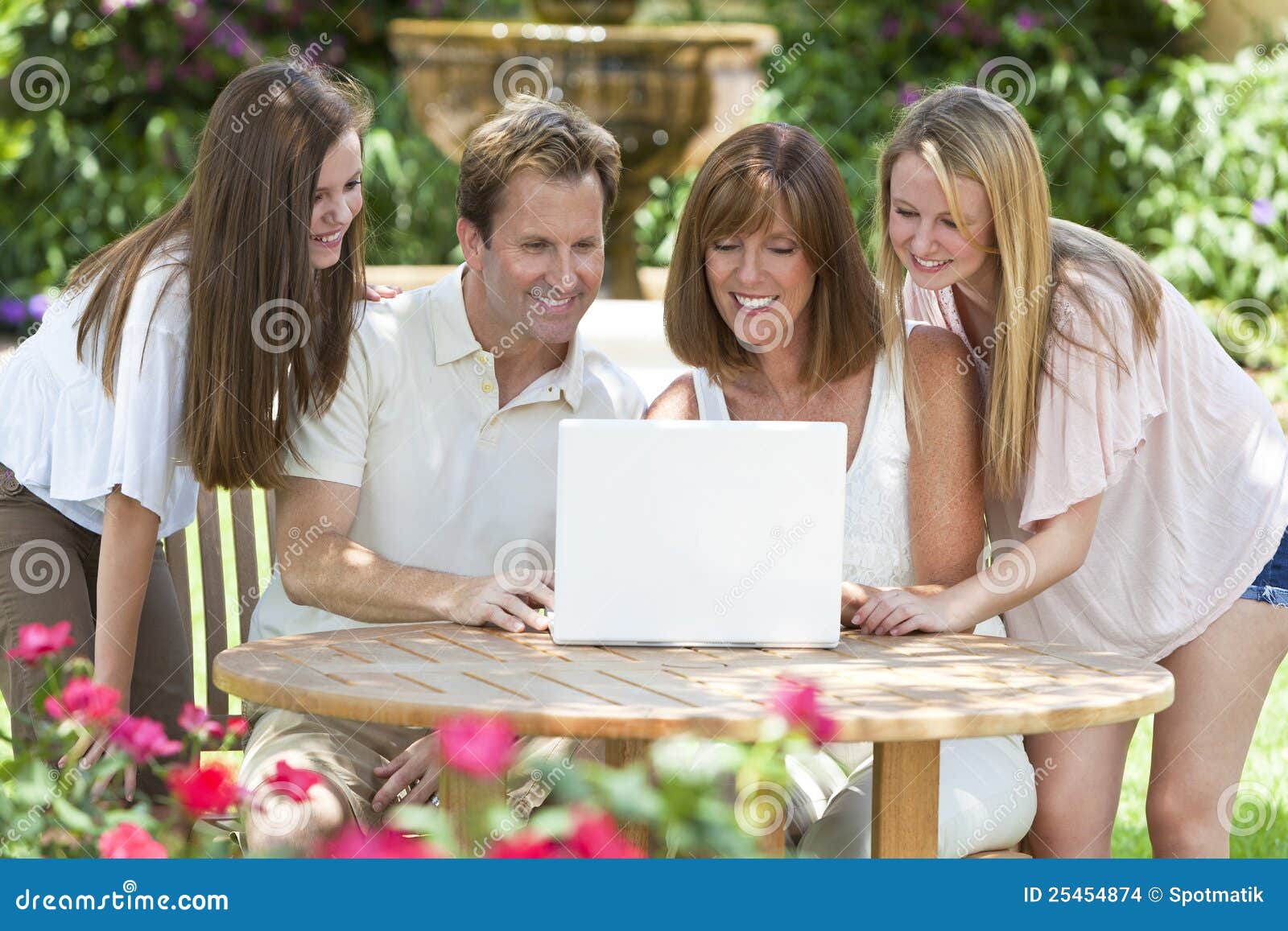 Family Using Laptop Computer Outside in Garden Stock Photo - Image of ...