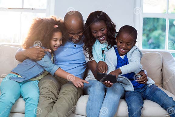 Family using mobile phone stock image. Image of cheerful - 78674075