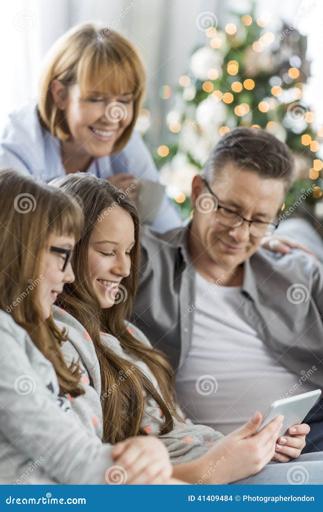 Family Using Tablet PC Together at Home Stock Photo - Image of ...