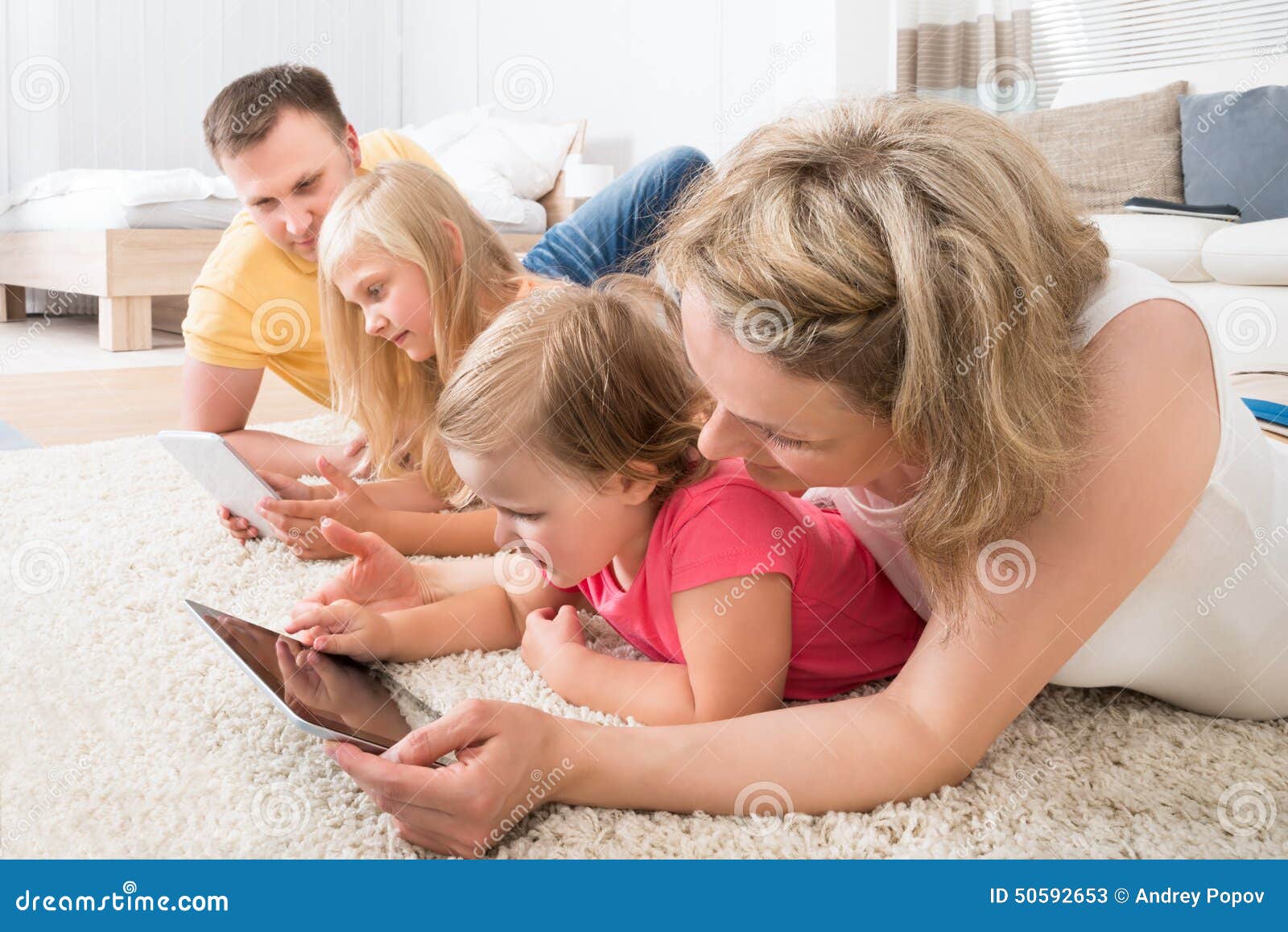 Family Using Gadgets Whilst Eating Breakfast Royalty-Free Stock Photo ...