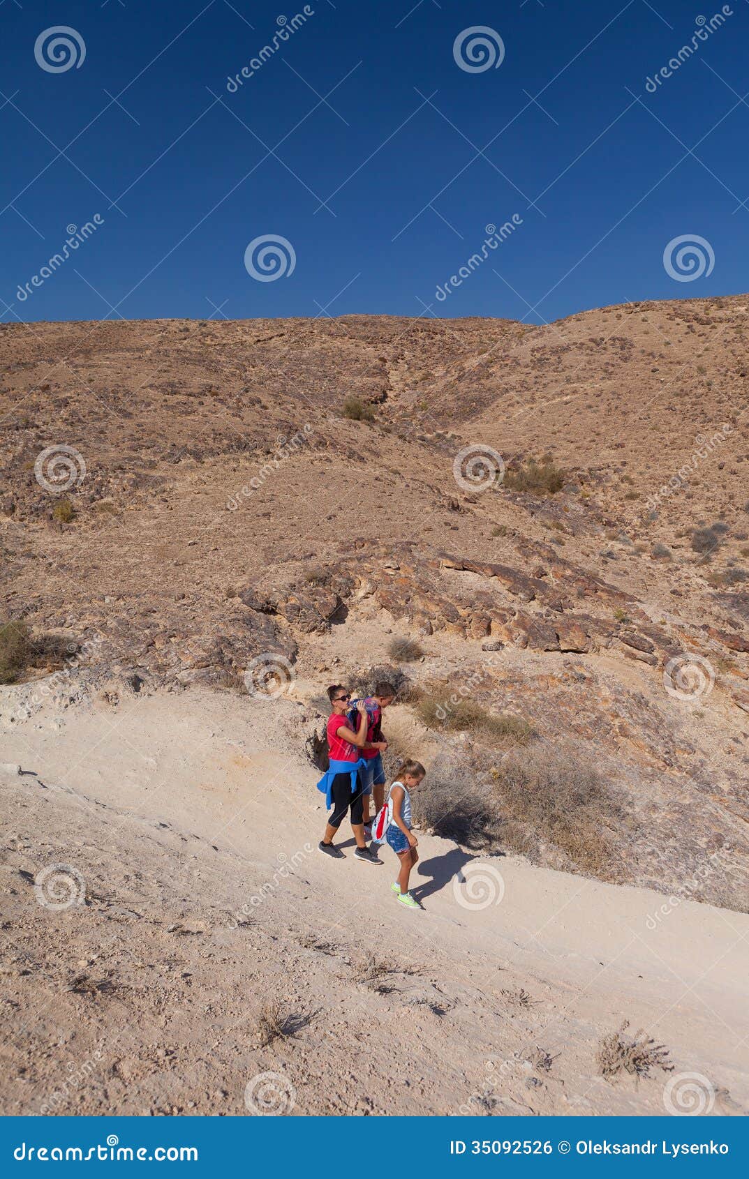 Family walk in the desert stock photo. Image of east - 35092526