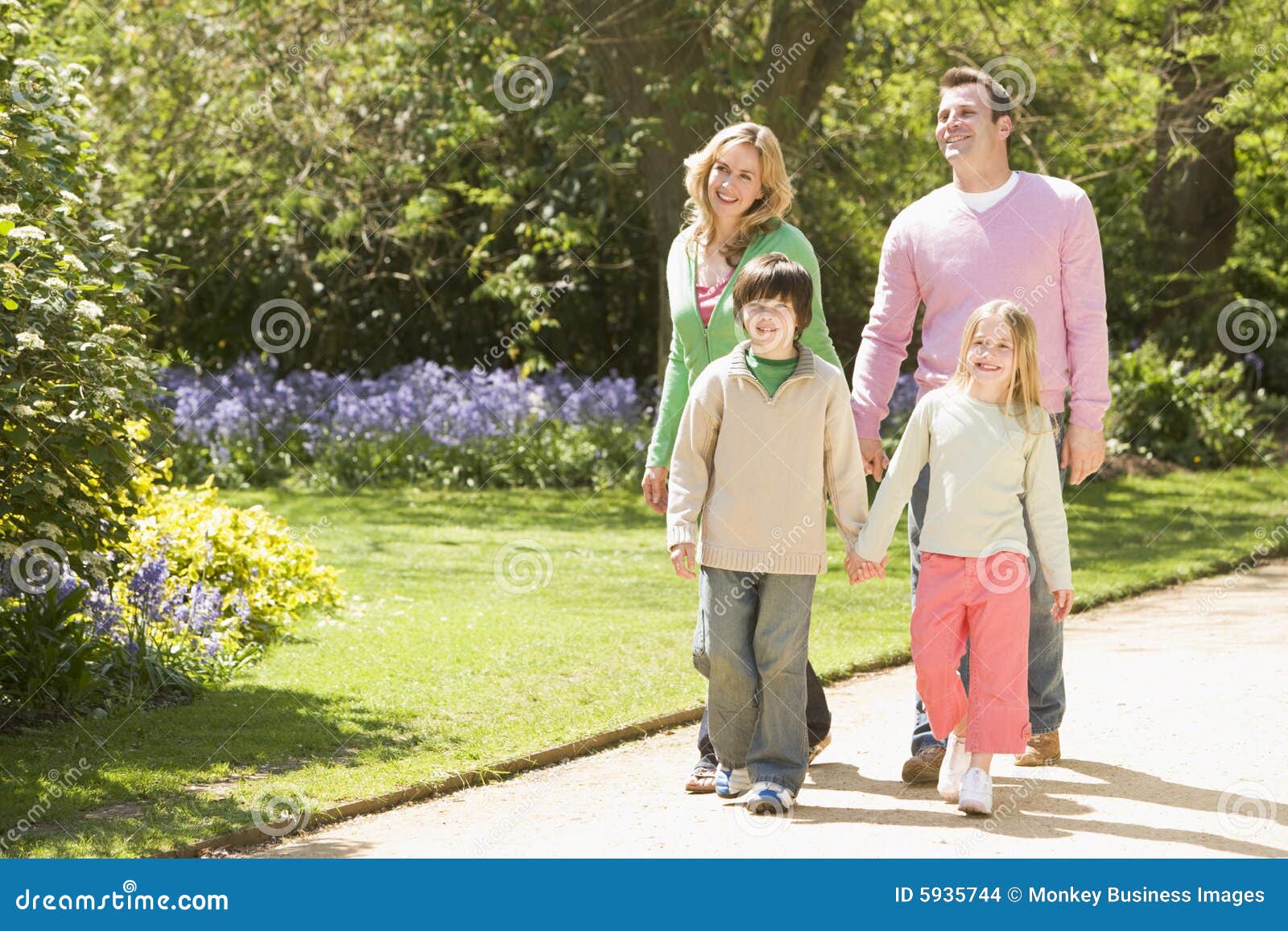 Family Walking on Path Holding Hands Smiling Stock Photo - Image of ...