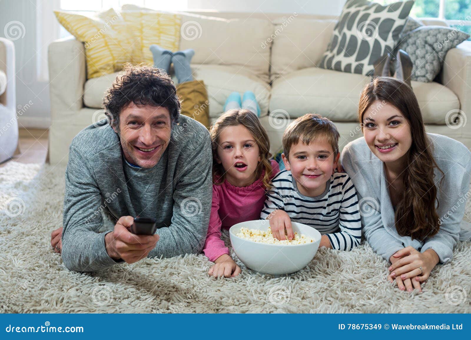 Family Watching Television while Lying on the Floor Stock Image - Image ...