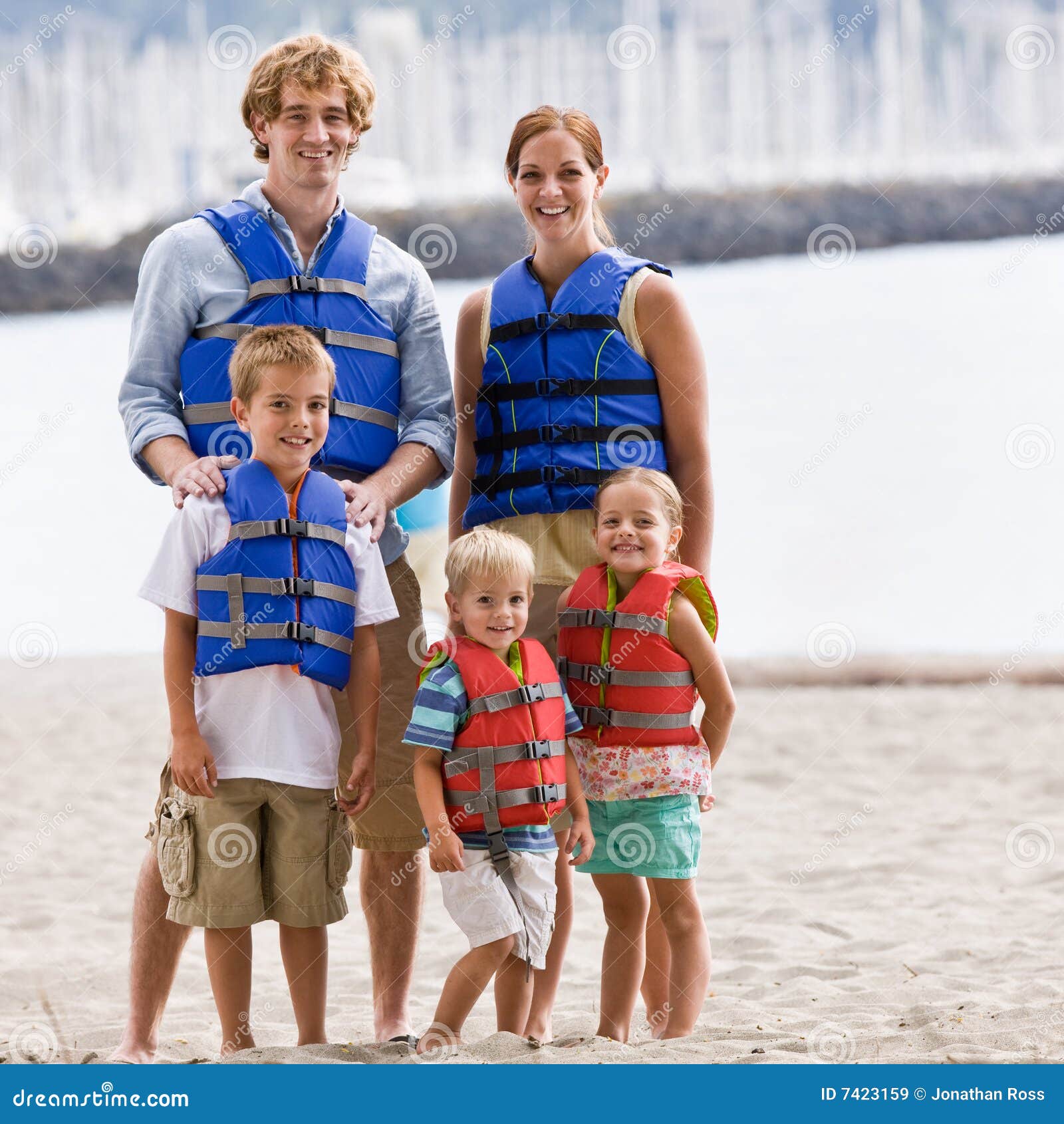 Family Wearing Life Jackets at Beach Stock Image - Image of child, five ...
