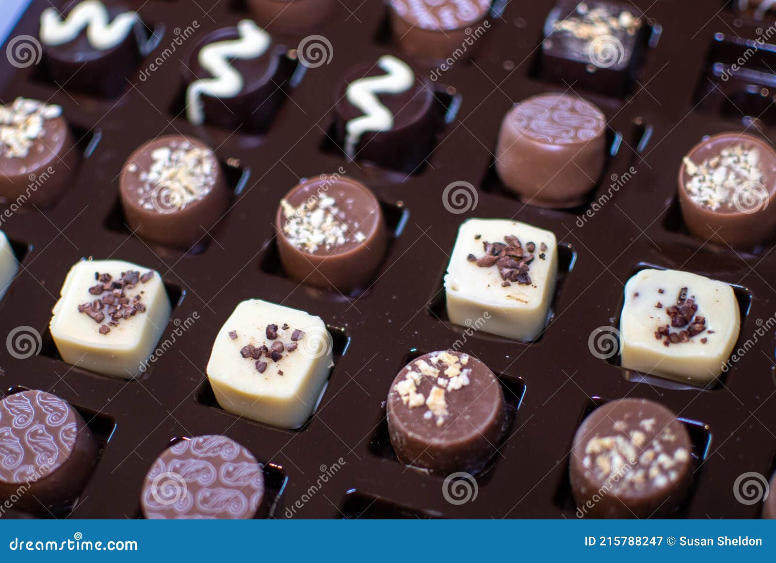 Fancy chocolates in a box stock image. Image of candy - 215788247